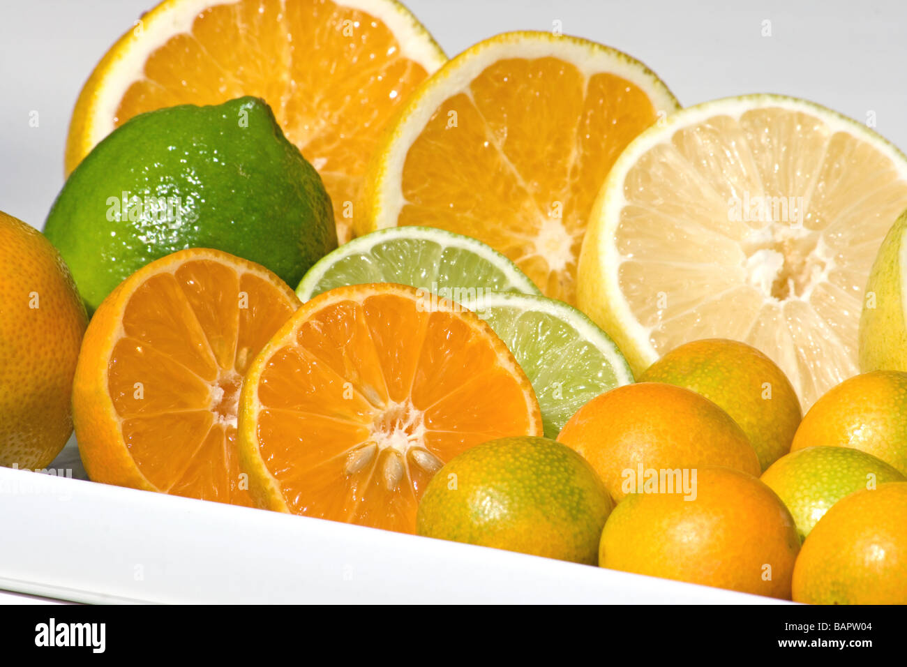 Assorted citrus on white background Stock Photo - Alamy