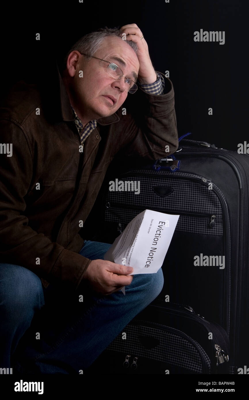 Man with suitcase; Man with an eviction notice Stock Photo - Alamy
