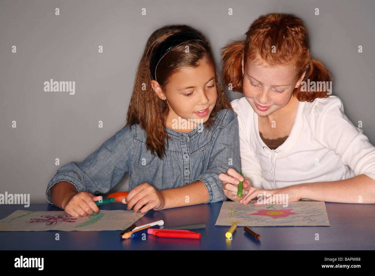 Girls coloring together Stock Photo - Alamy