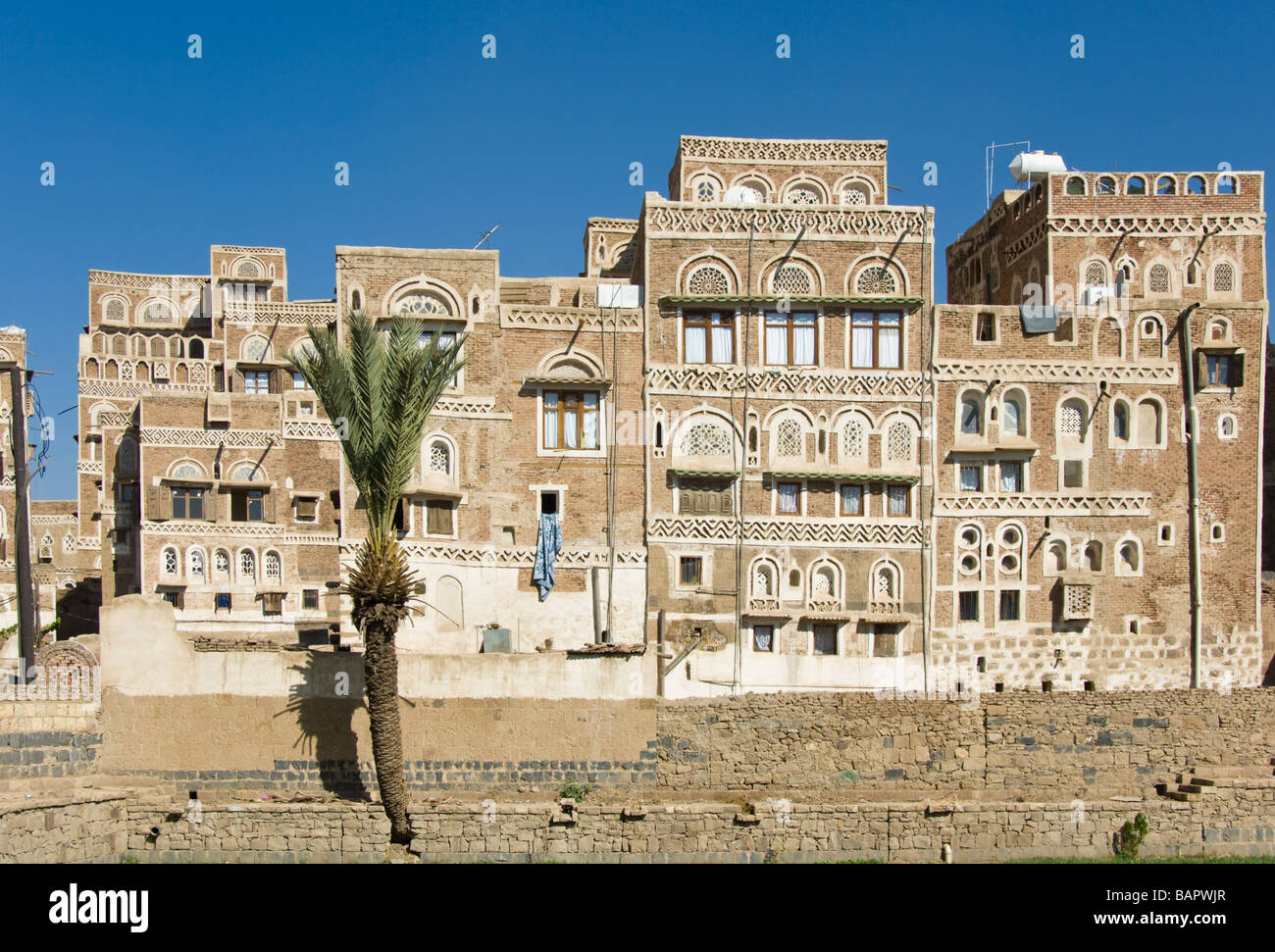 Traditional garden bustan with buildings in the old town district of ...