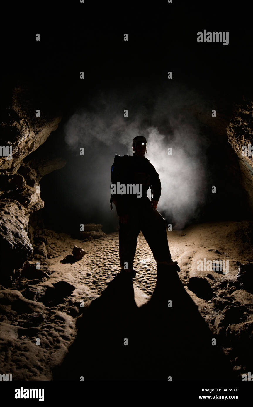Man in a cave; spelunking Stock Photo - Alamy