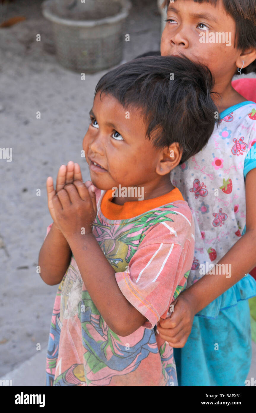 Moken kids put palms together wai and queue up to get sweet from ...
