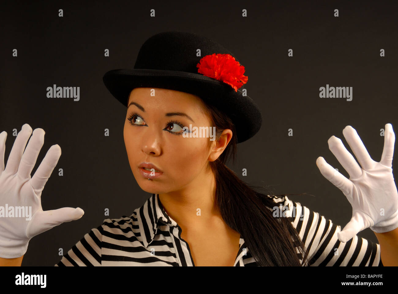 Girl in bowler hat mime Stock Photo - Alamy