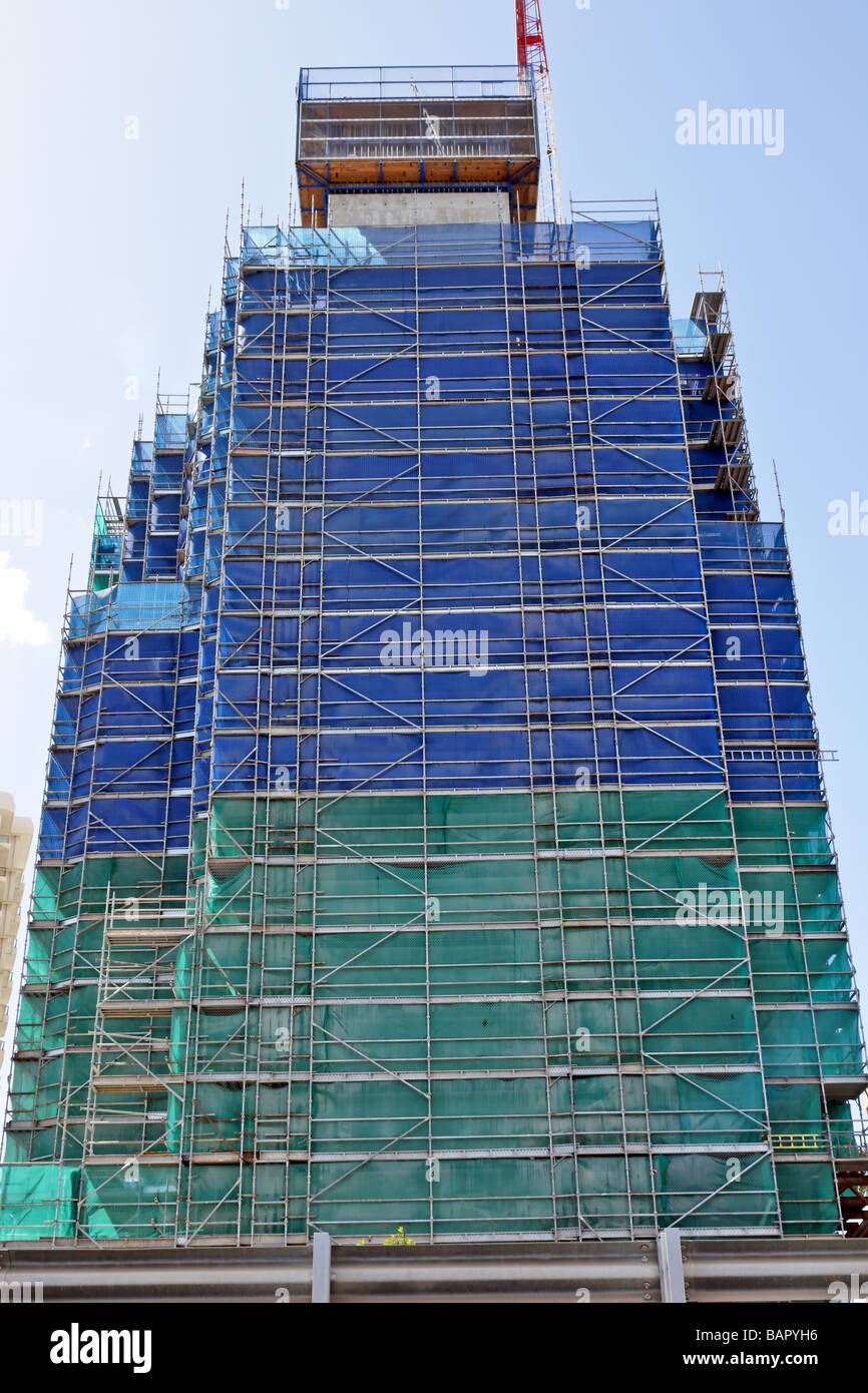 Building construction showing scaffolding and protective netting Stock ...