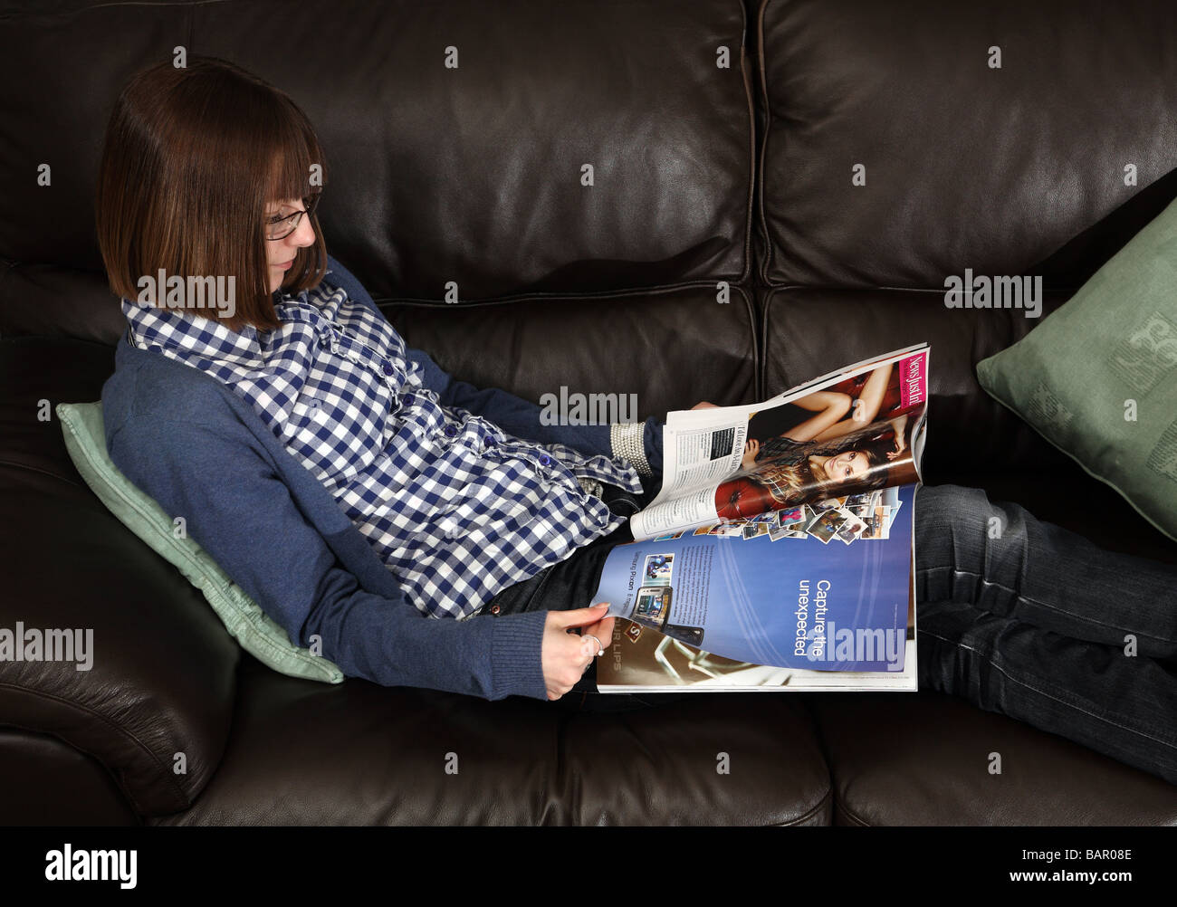 teenage girl reading magazine Stock Photo - Alamy