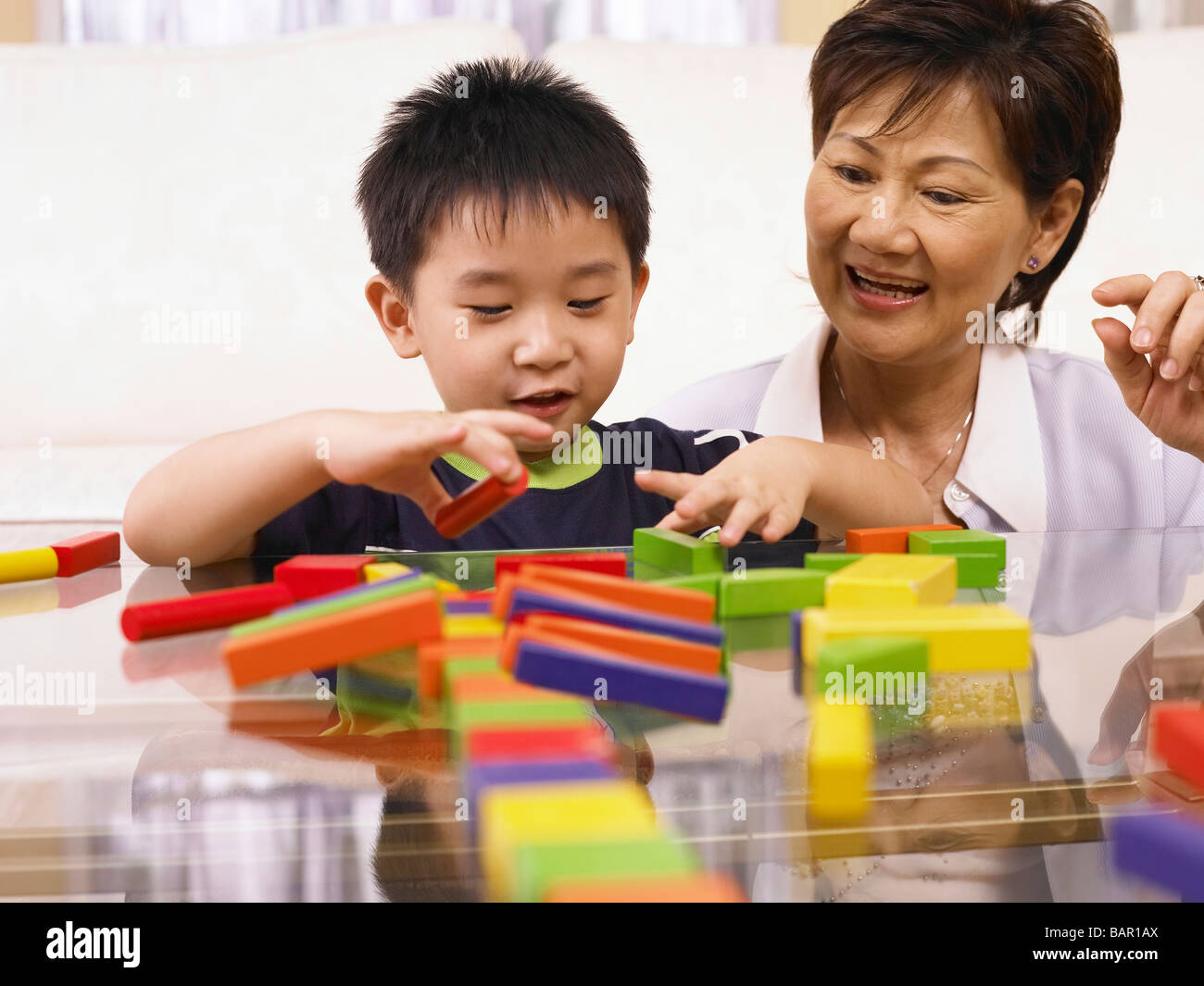 grandmother having fun with grandson at living hall Stock Photo - Alamy