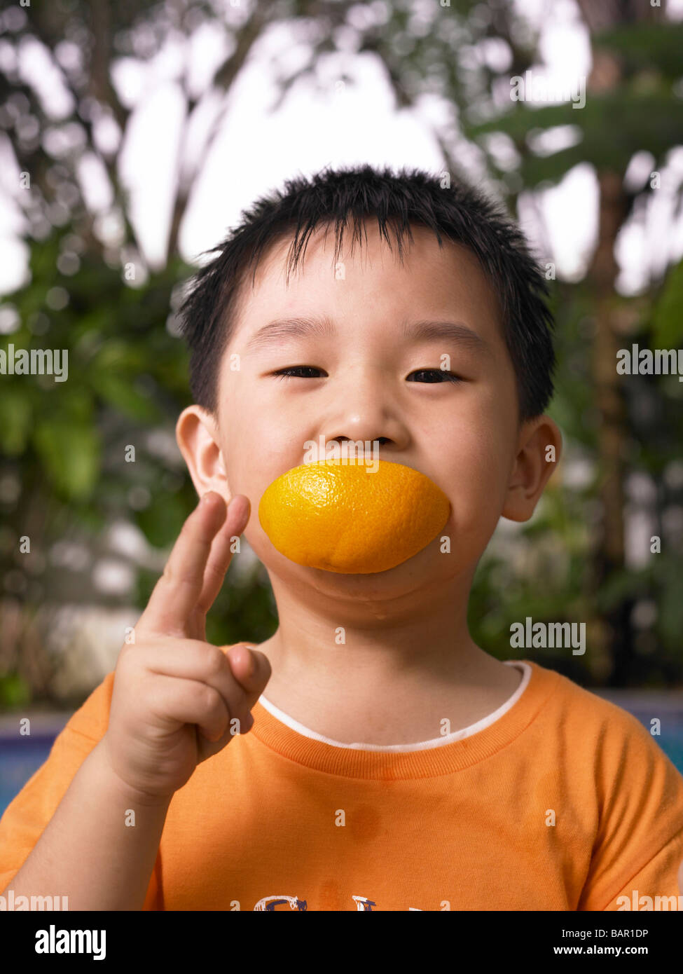 little boy eating orange fun Stock Photo - Alamy