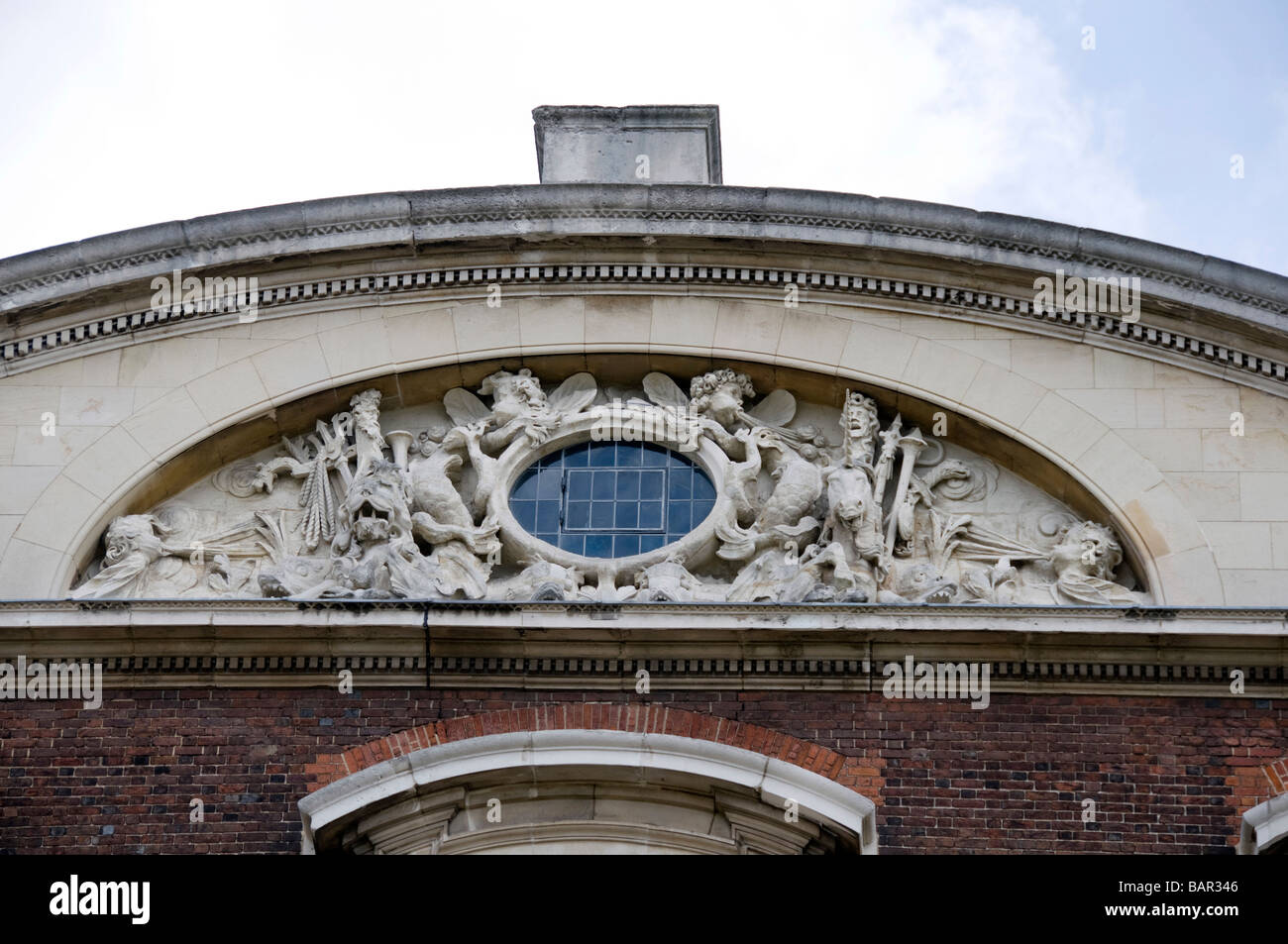 A carving on a building with a round window Stock Photo - Alamy