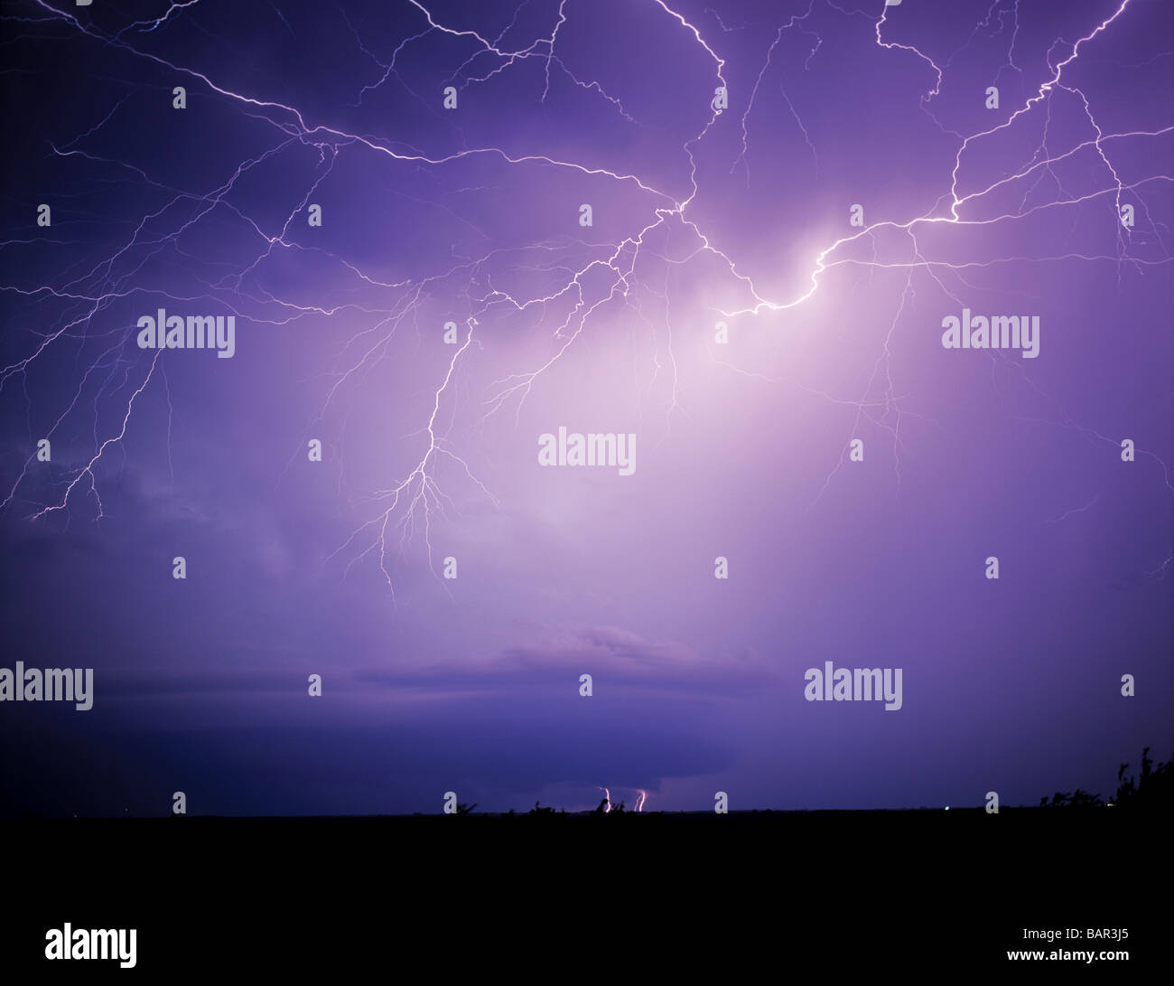 A bolt of cloud to cloud lightning crawls across the anvil of a ...