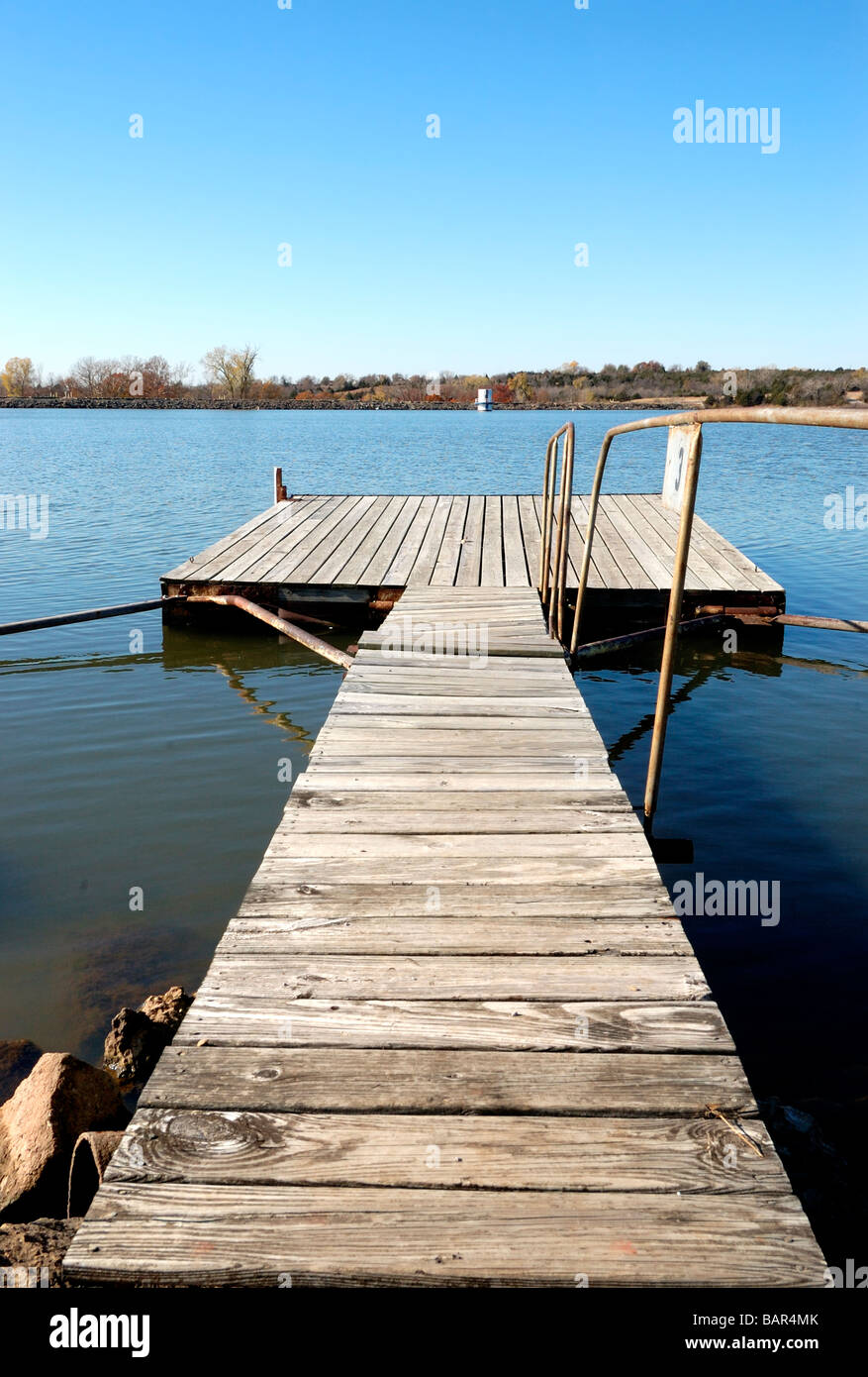 A wooden floating boat dock extending into an Oklahoma lake. USA Stock ...