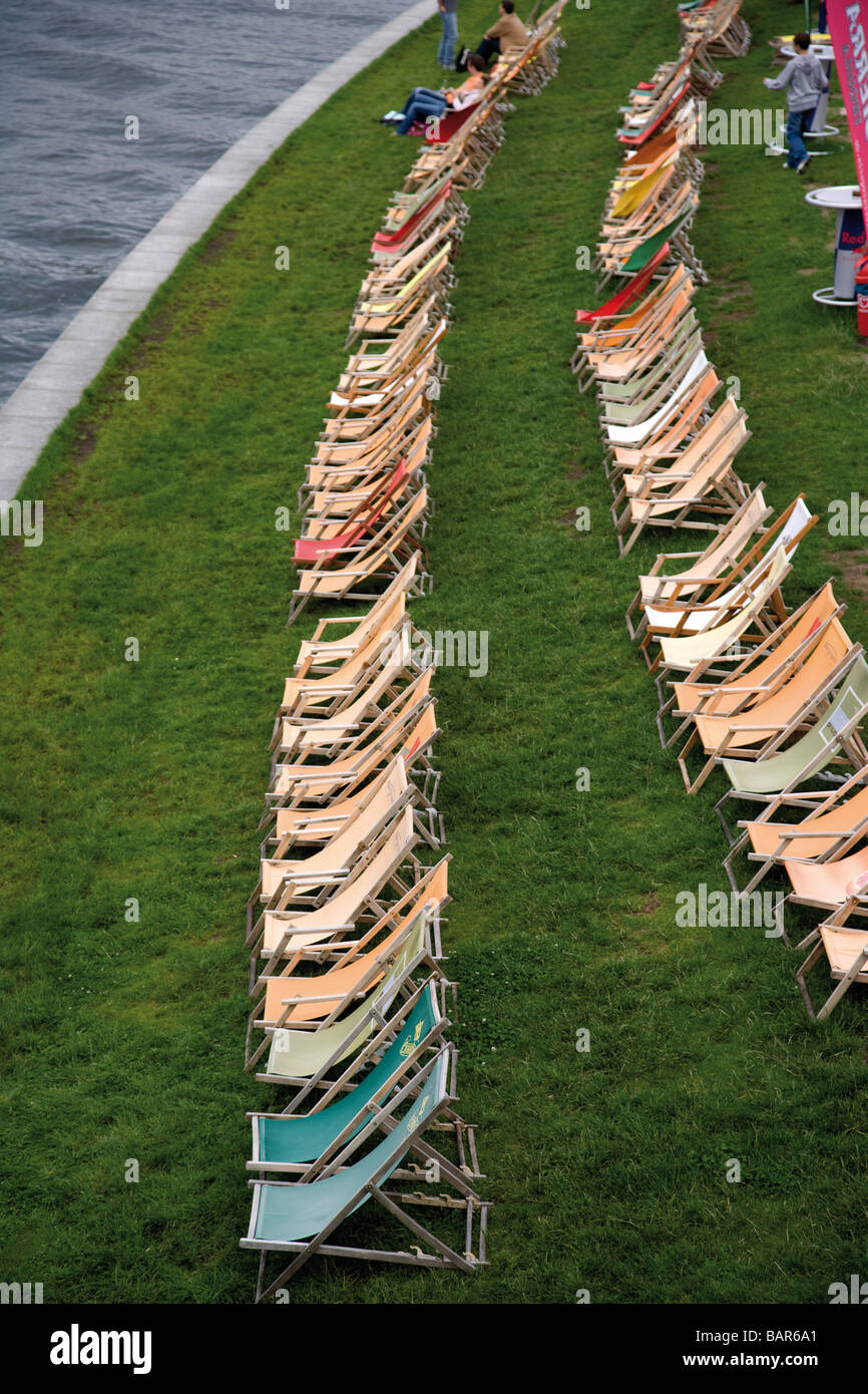Germany, Berlin, Spree river, canvas chairs on the waterfront Stock ...