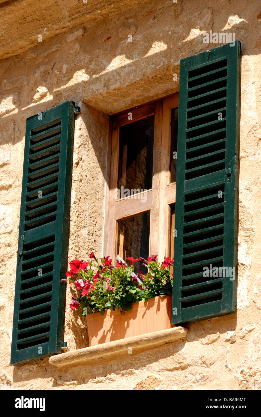 Green-shuttered window with colorful flower box in Alcudia, Mallorca ...