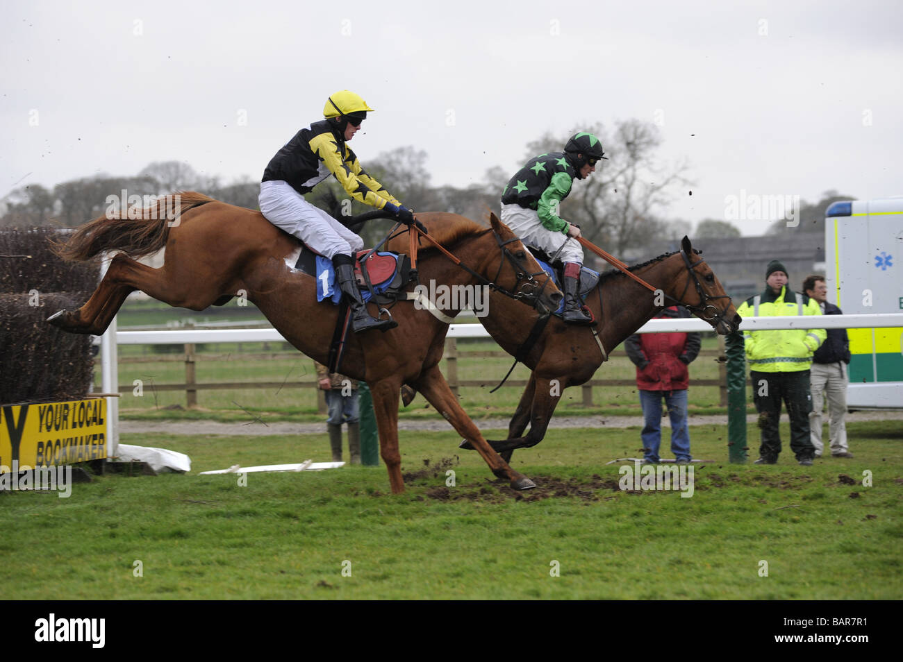 Horses jumping last fence at Sedgefield races UK Stock Photo - Alamy