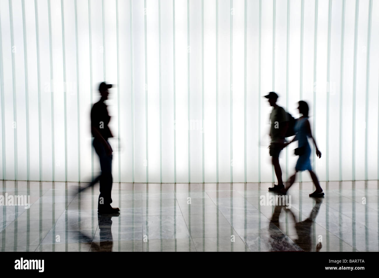 Person walking in silhouette against a white patterned background Stock ...