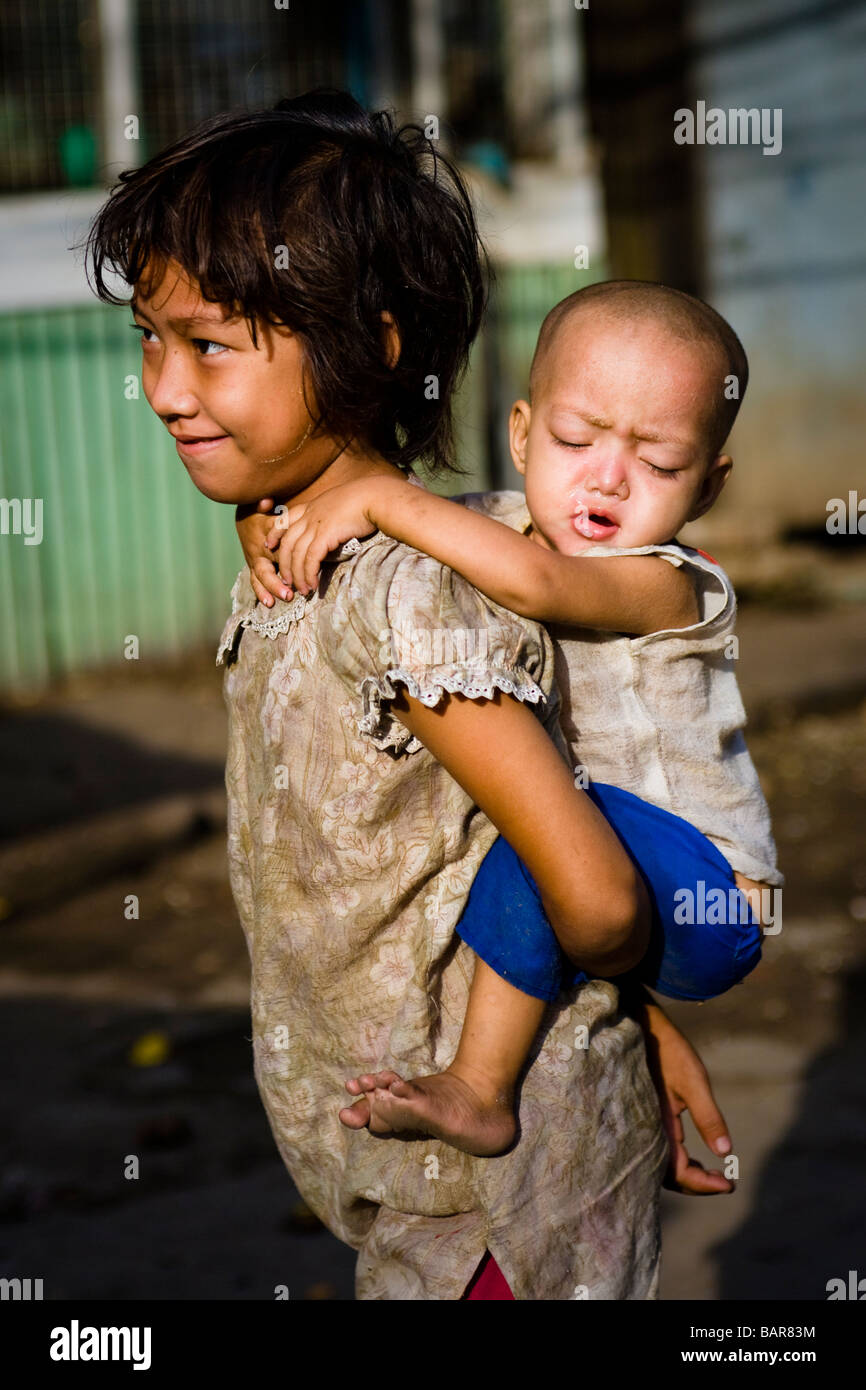 child carrying baby Stock Photo - Alamy
