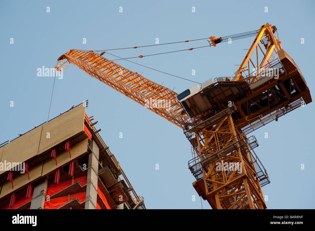 Construction cranes at work putting up high rise buildings Stock Photo ...