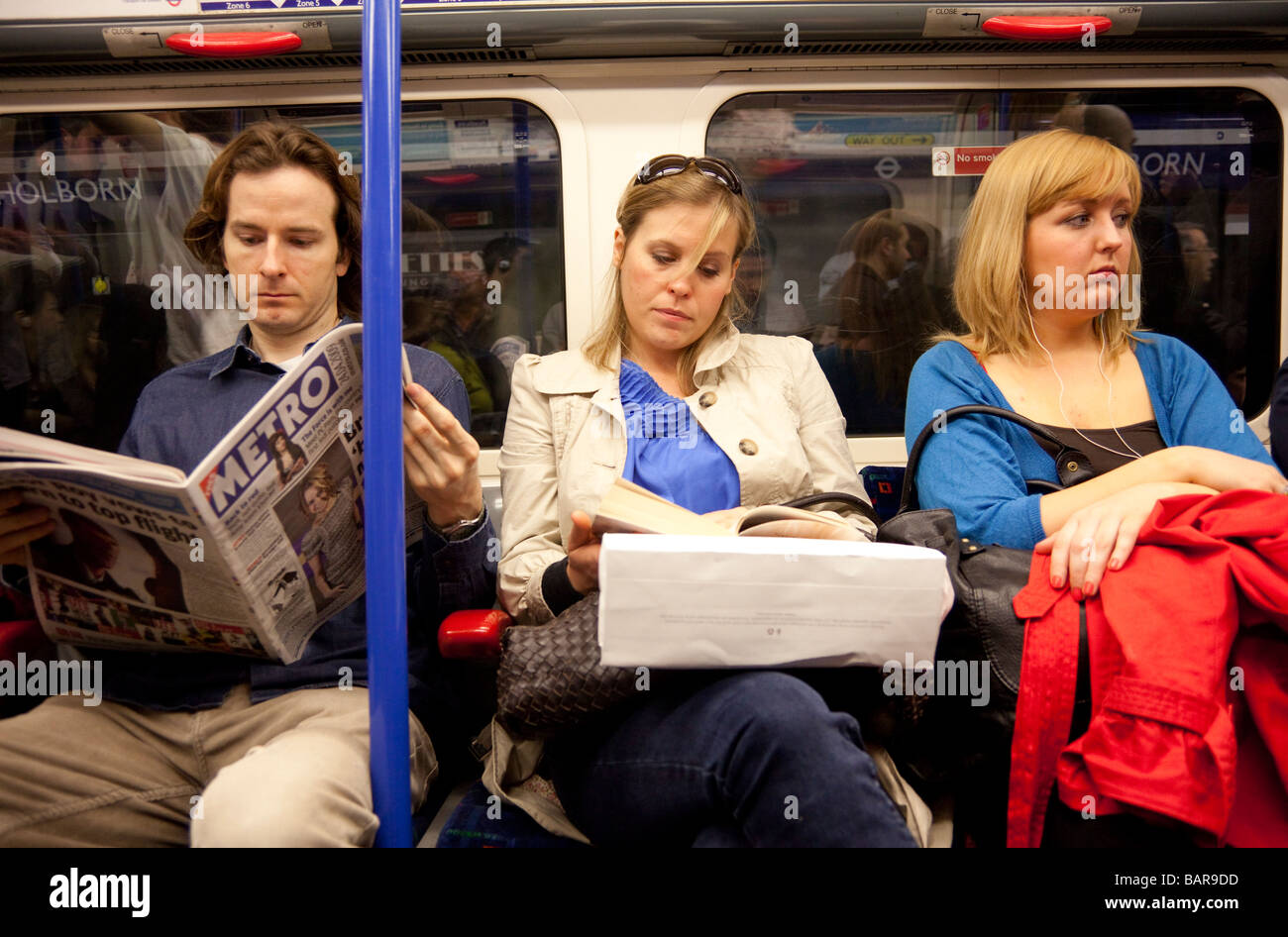 commuters reading on London Underground, London, England Stock Photo ...