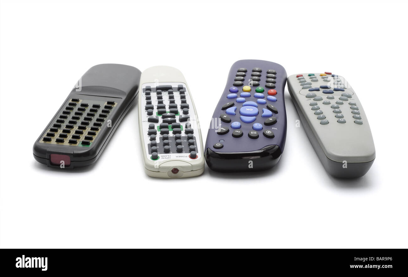 Assortment of wireless remote controllers arranged on white background ...