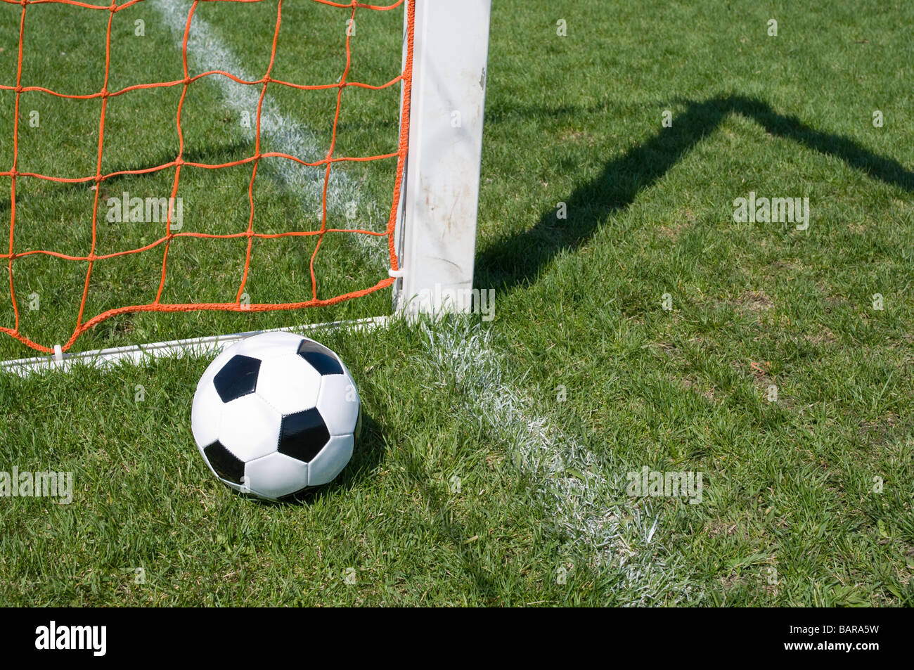 Soccer ball in the goal net Stock Photo - Alamy