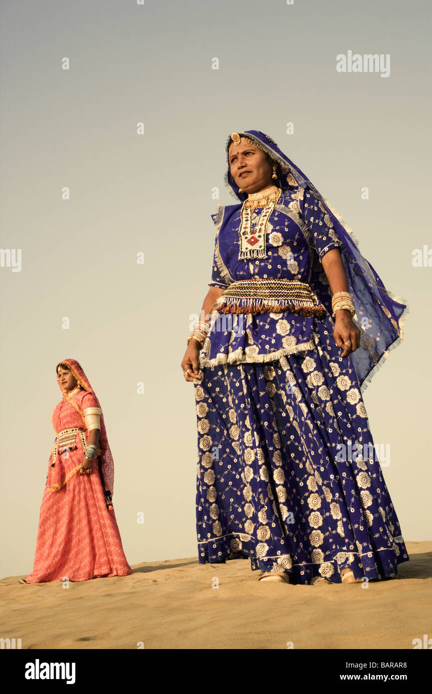 Two women standing in a desert, Thar Desert, Jaisalmer, Rajasthan ...
