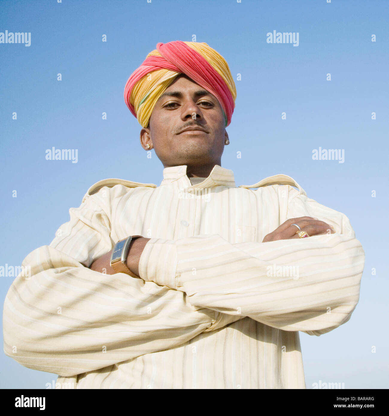 Portrait of a man standing with his arms crossed, Jaisalmer, Rajasthan ...