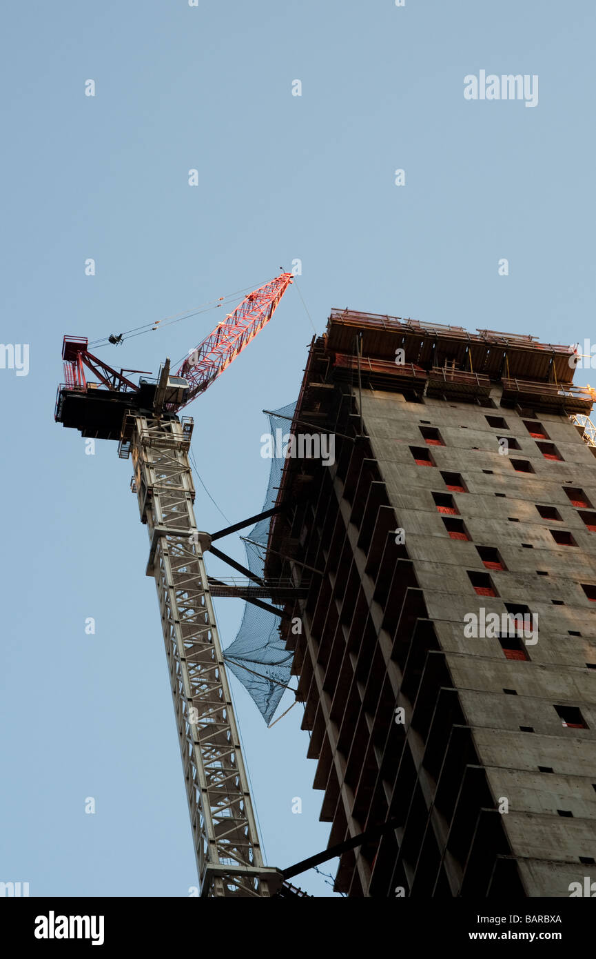 Construction cranes at work putting up high rise buildings Stock Photo ...