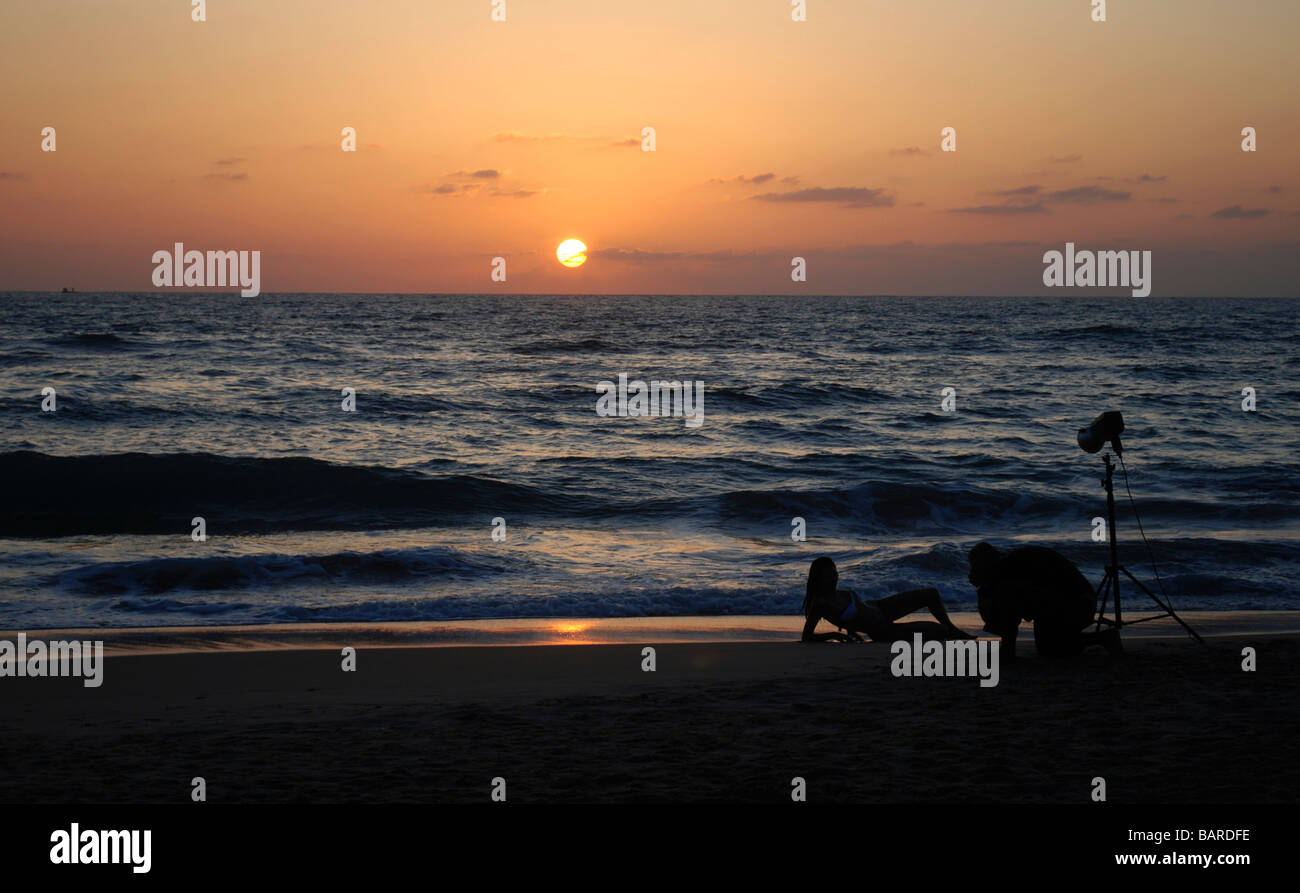 Silhouette of a Photographer and model at sunset on the beach Stock ...