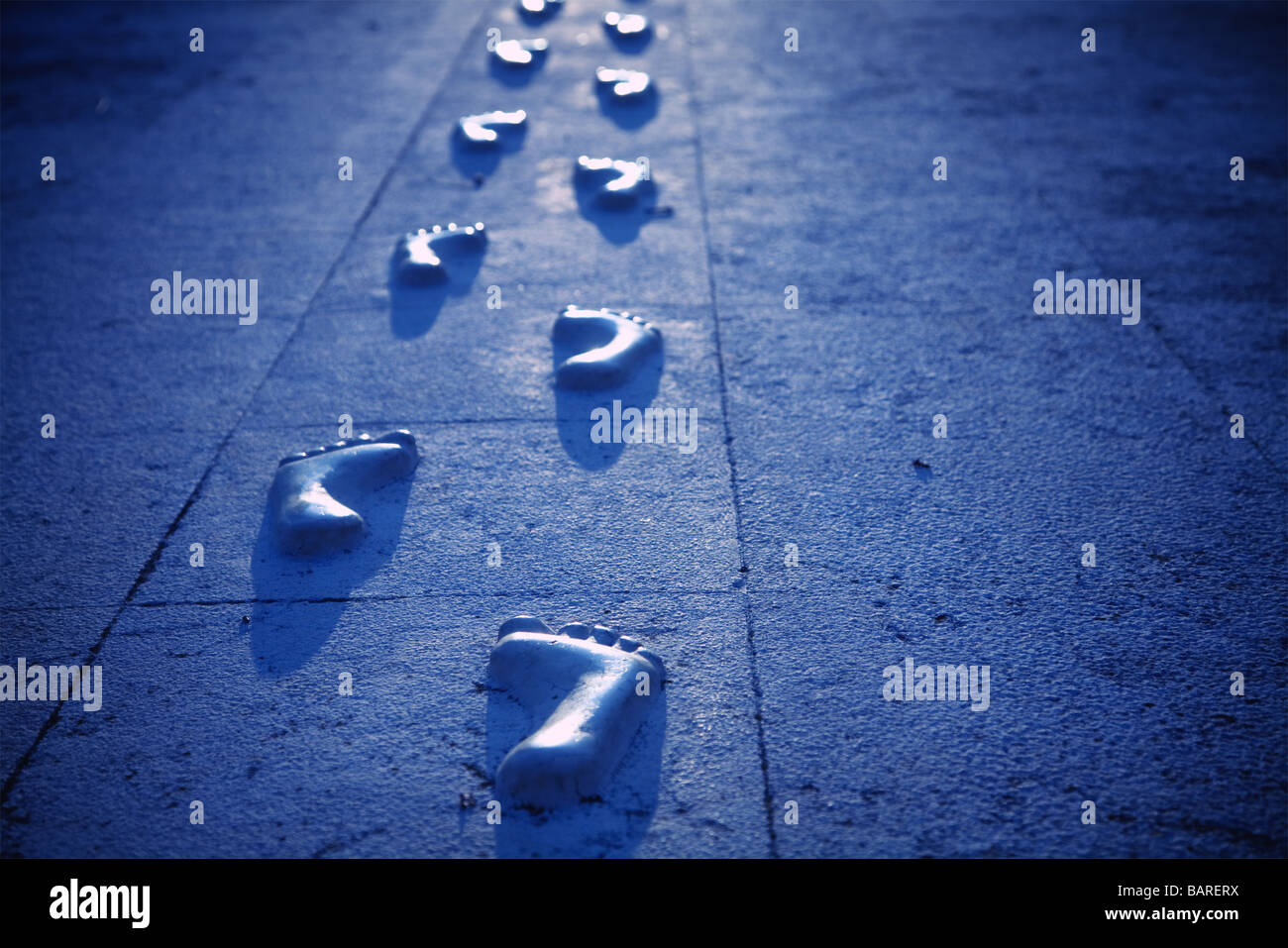 Footsteps on the road Stock Photo - Alamy