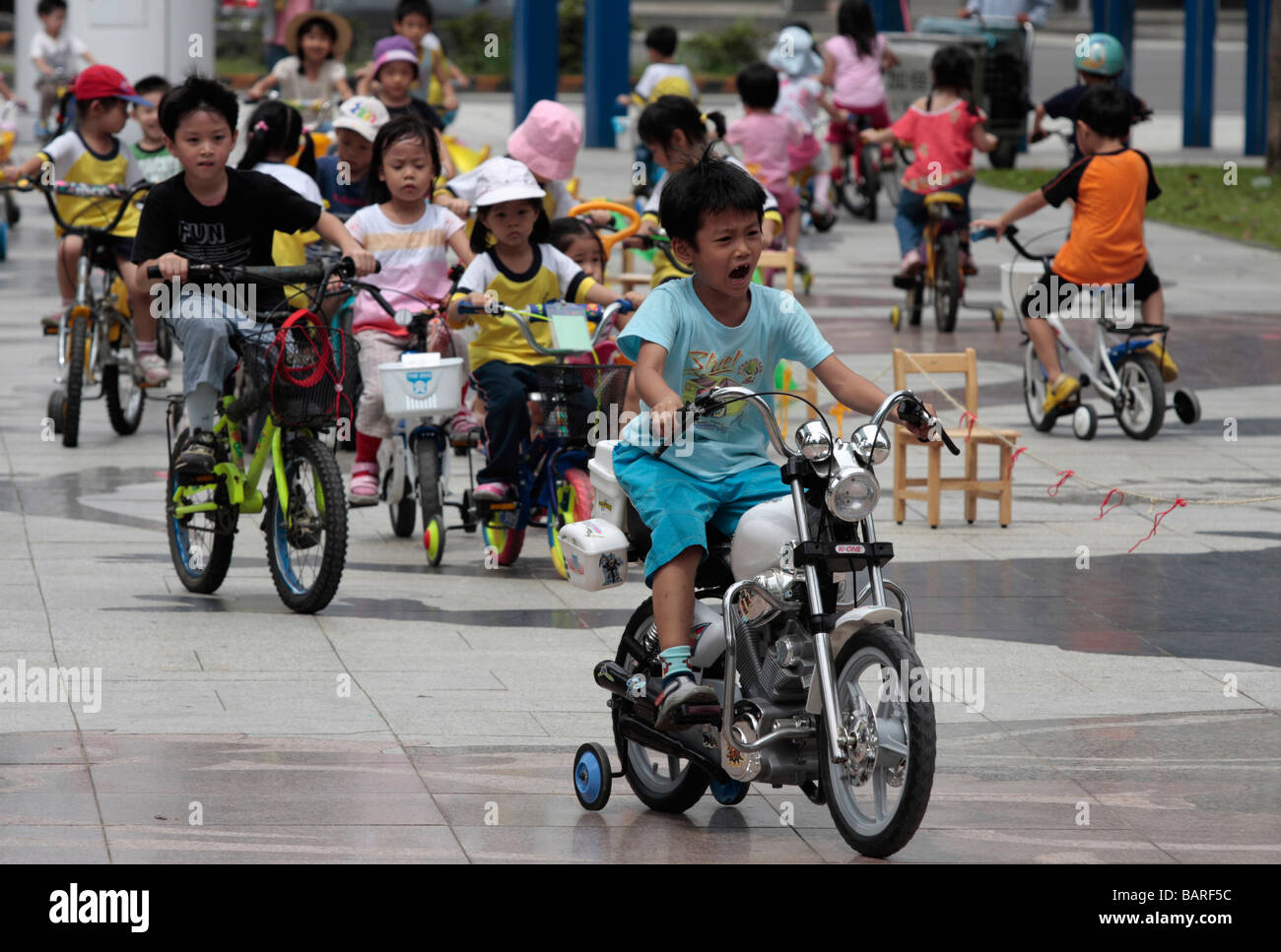 Children ride bicycles on street Stock Photo - Alamy