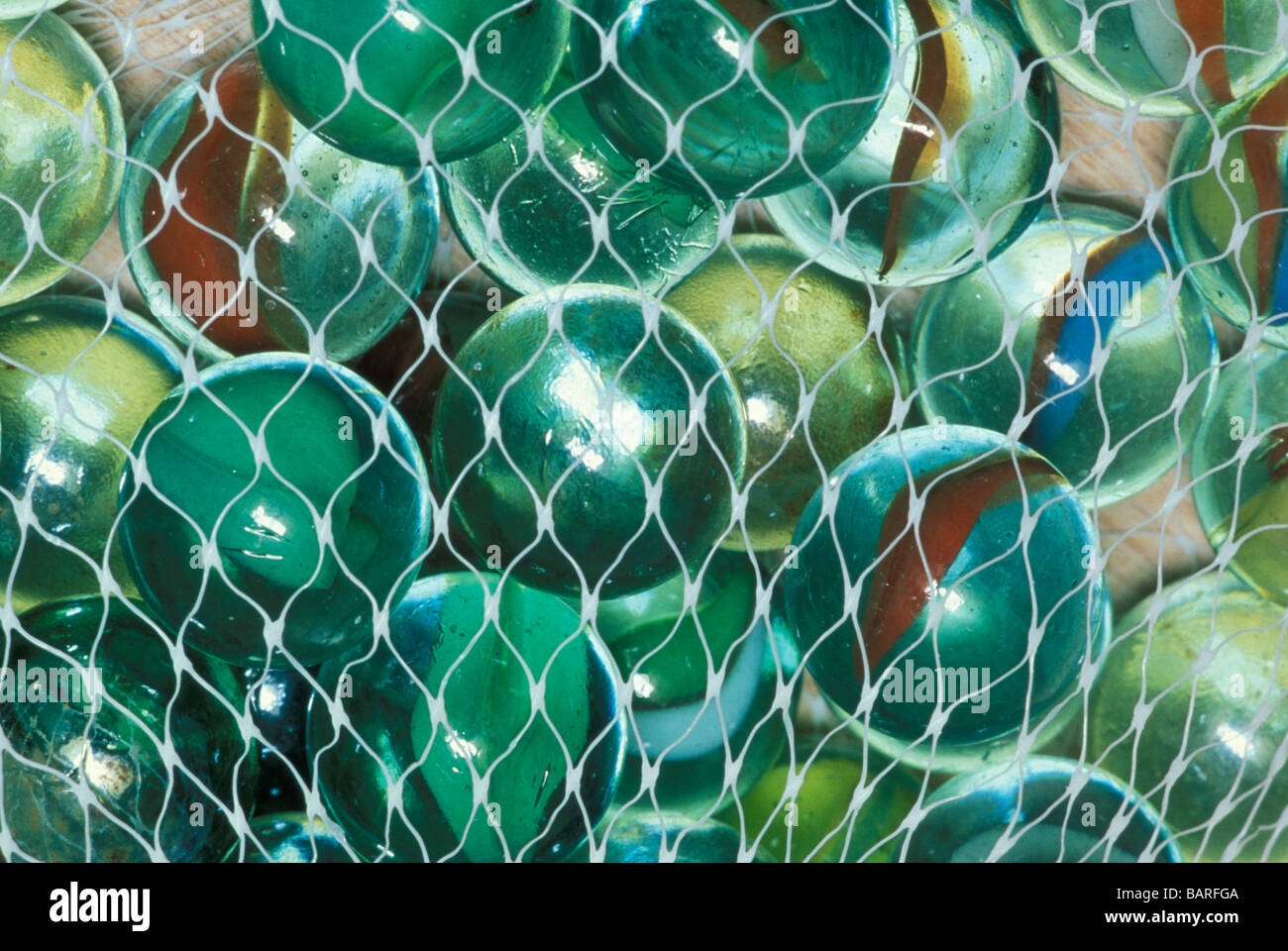 colored marbles in net Stock Photo - Alamy
