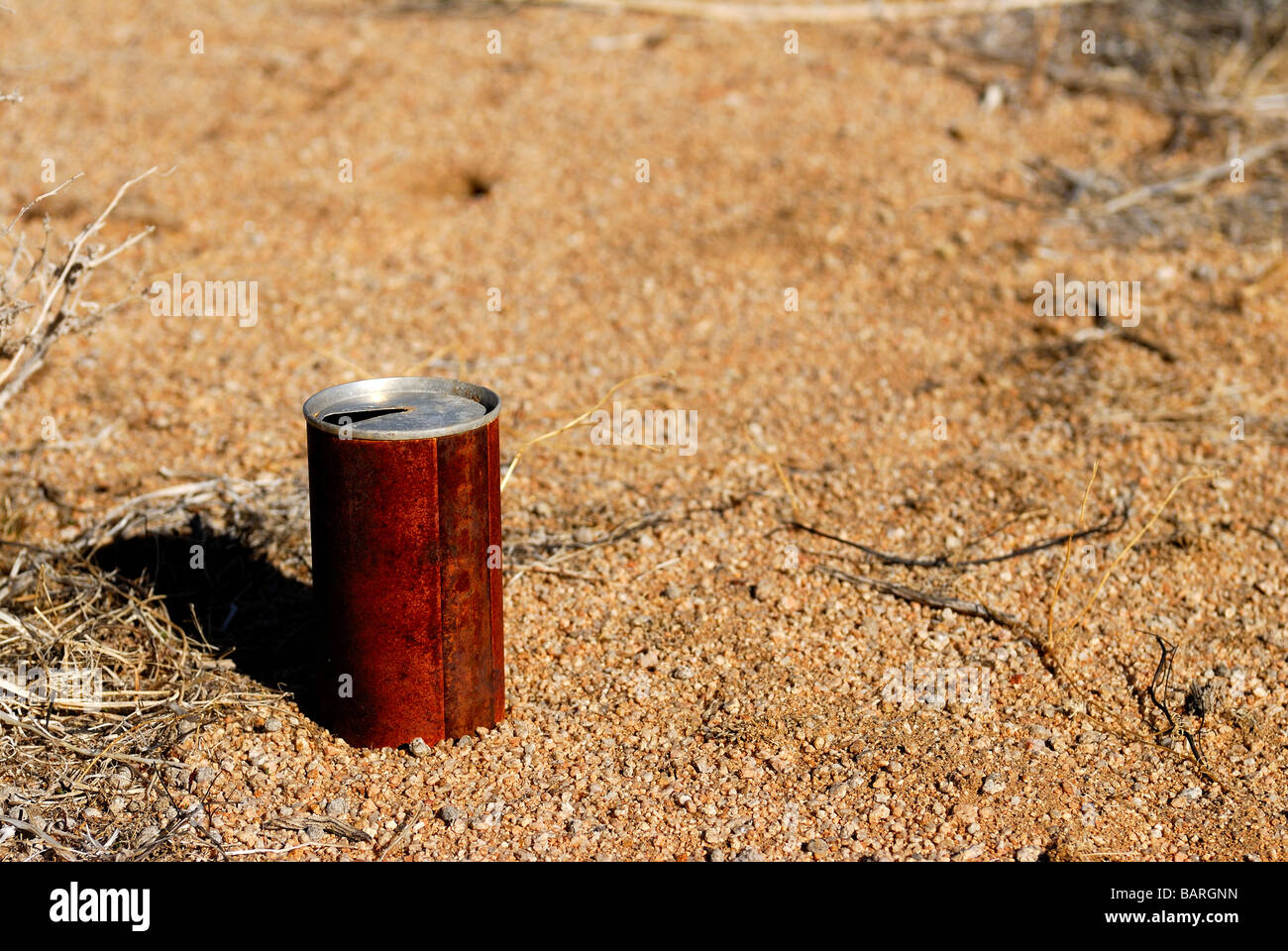 a rust can on the desert ground Stock Photo - Alamy