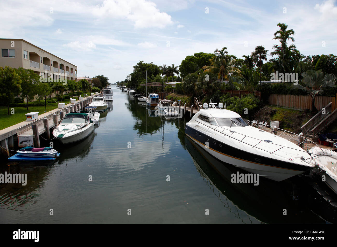 Florida Canal with boats moored Stock Photo - Alamy