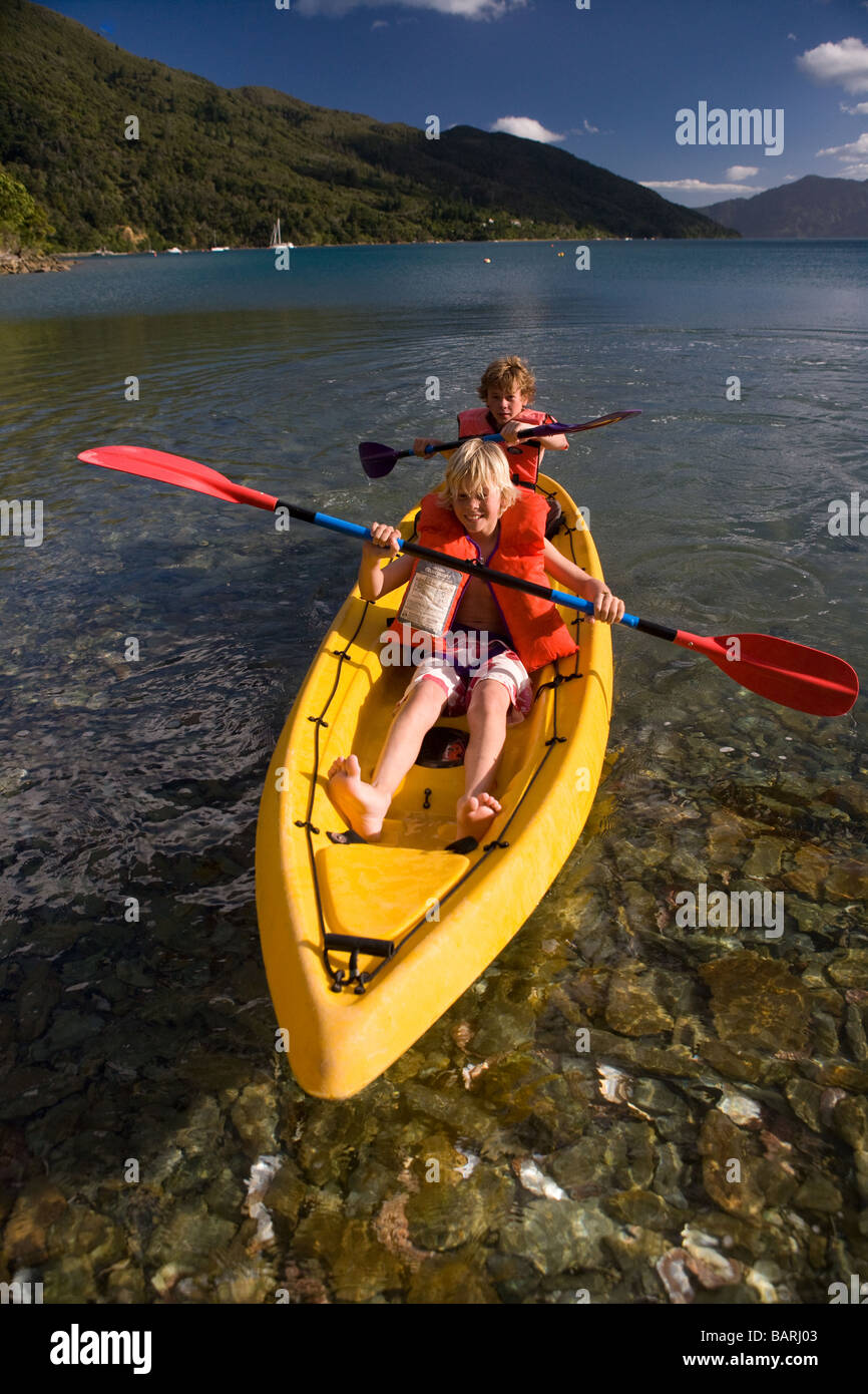 Two boys kayaking in the Marlborough Soundd South Island New Zealand ...