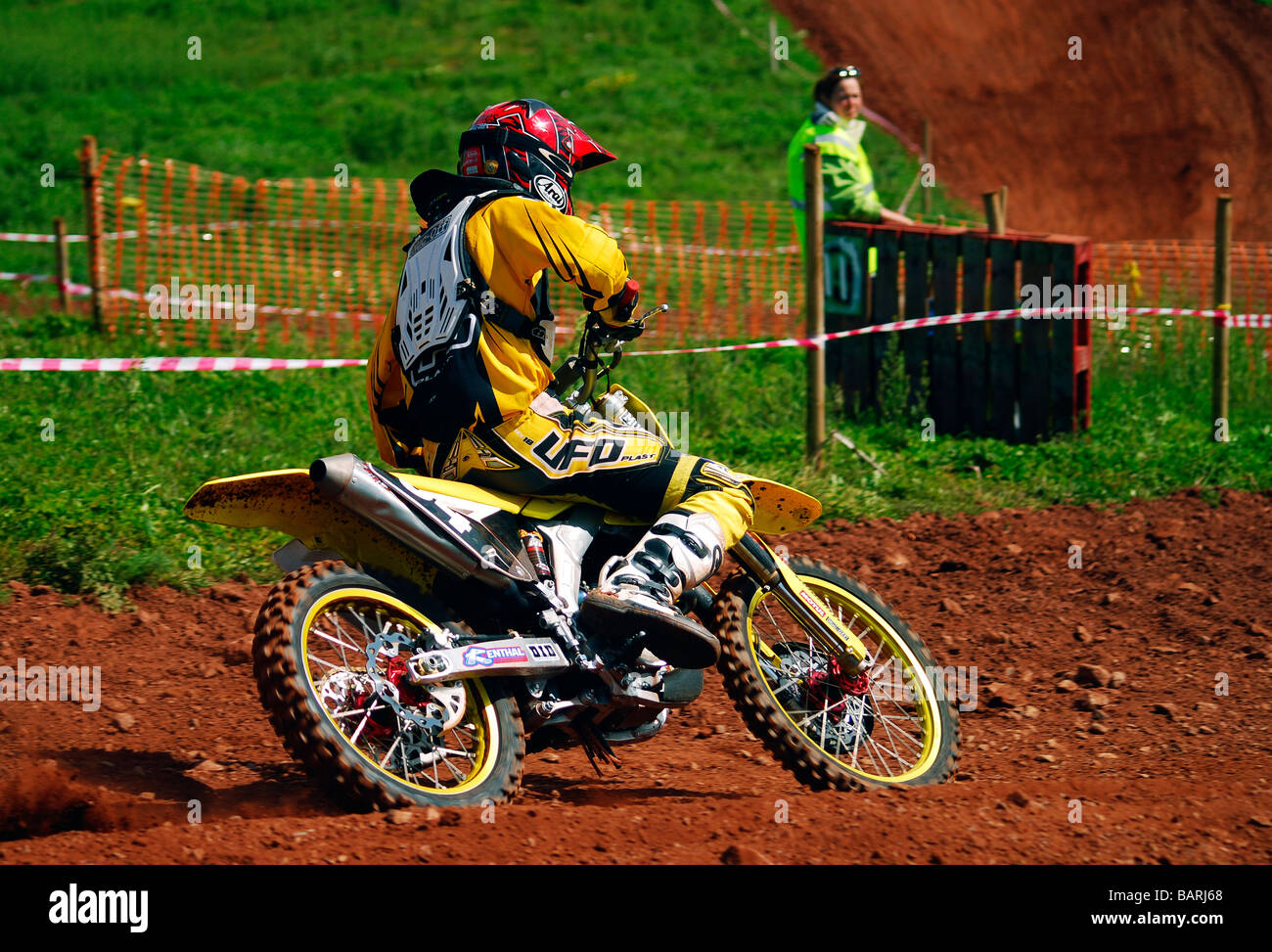 Motocross rider coming fast out of a corner leaning over Stock Photo ...