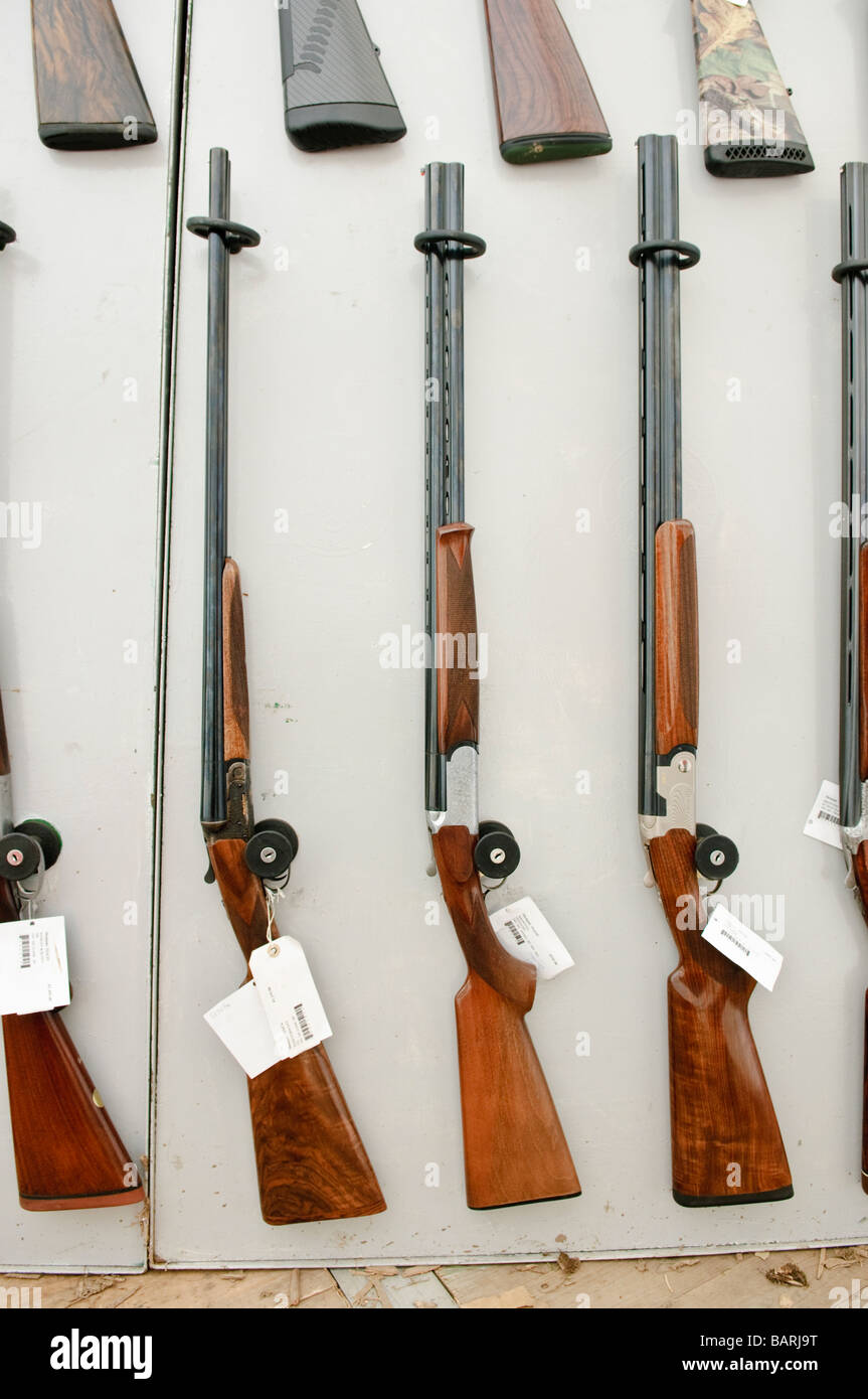 Racks of shotguns for sale at a country fair Stock Photo - Alamy