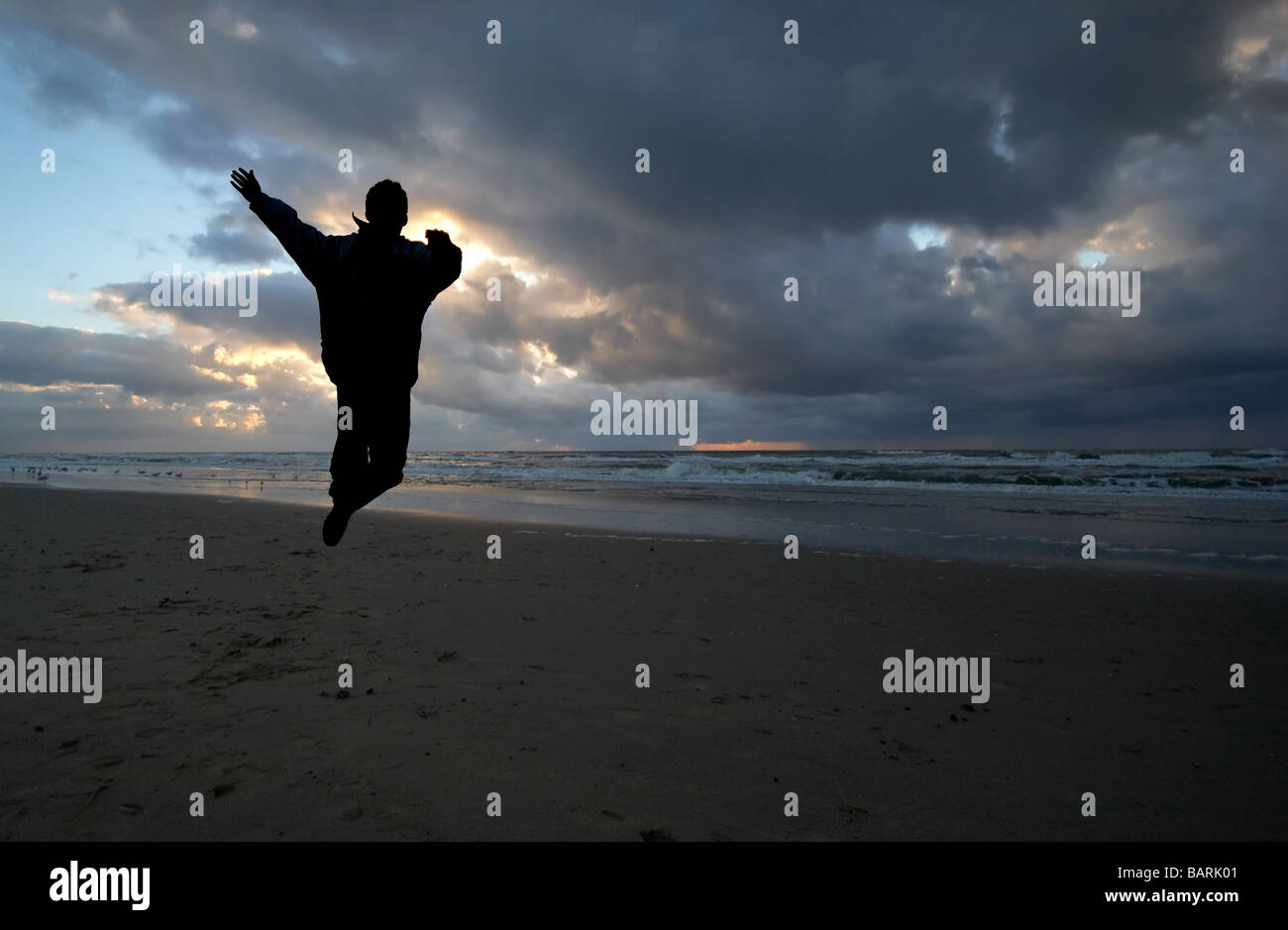 jump for joy on the beach with sunset Stock Photo - Alamy