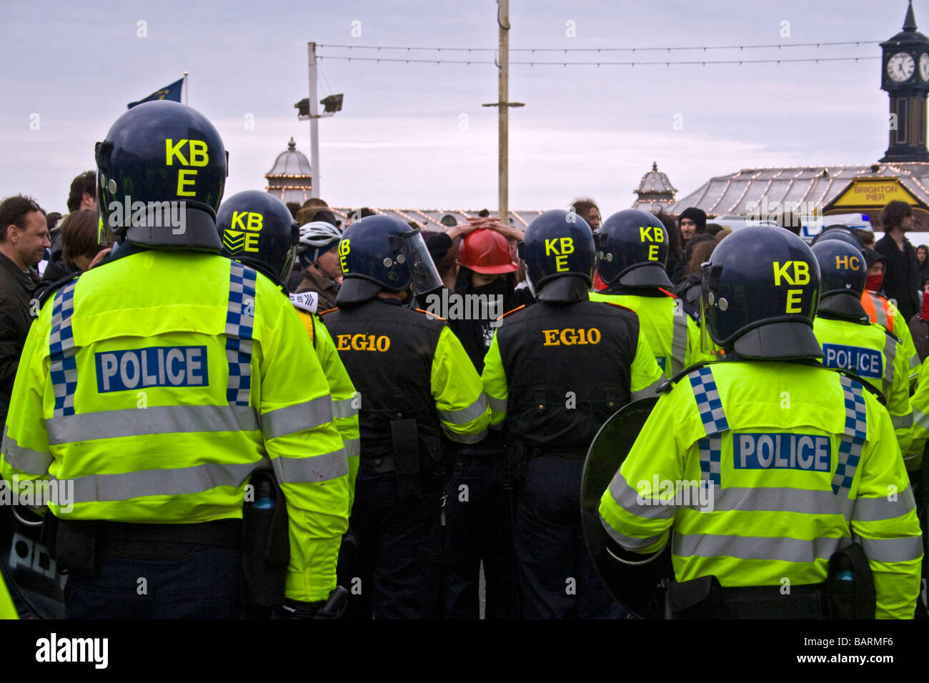 Riot police controlling crowds and masked protester during may day ...