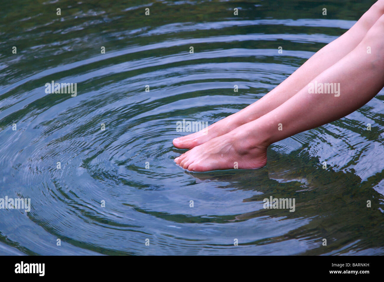 Young woman dipping feet in hi-res stock photography and images - Alamy