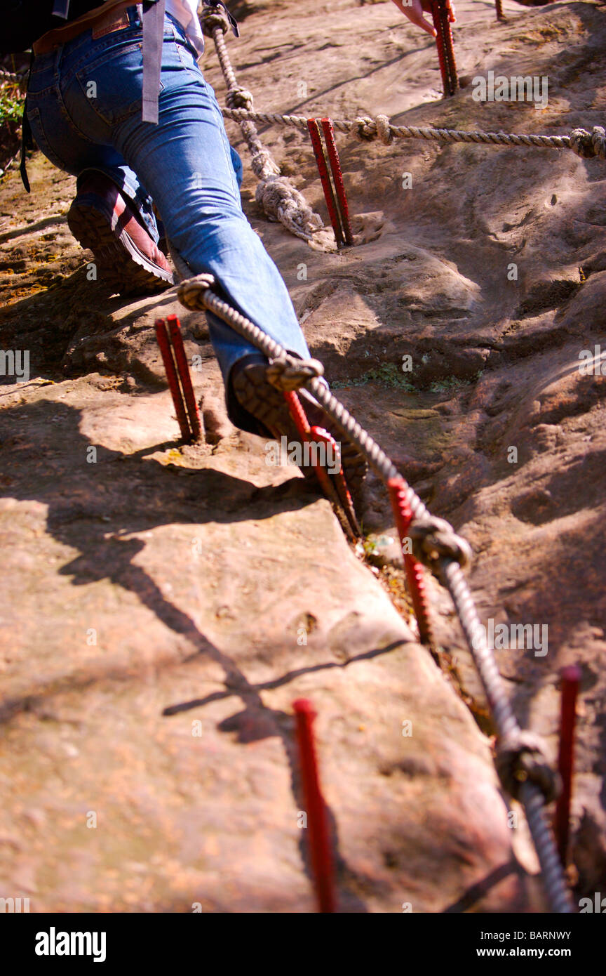 Woman climbing rock low section Stock Photo - Alamy