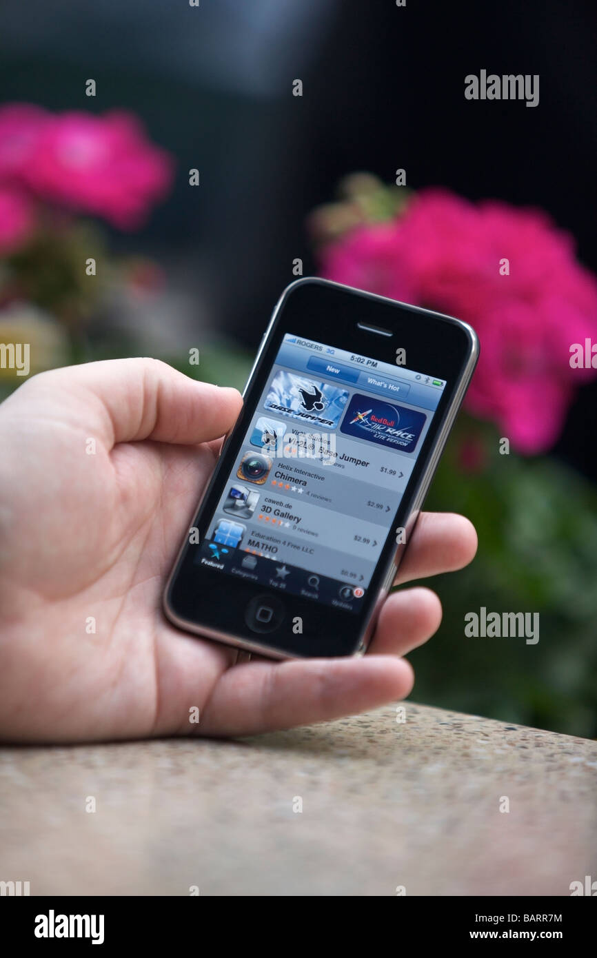 Man hand holding iPhone showing iPhone application Stock Photo - Alamy