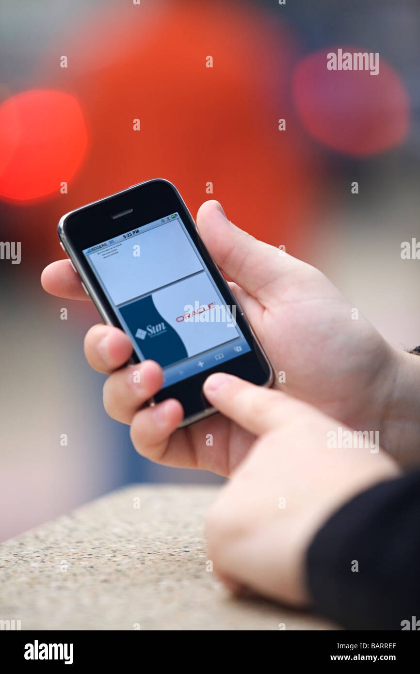 Man hand holding iPhone showing iPhone application Stock Photo - Alamy