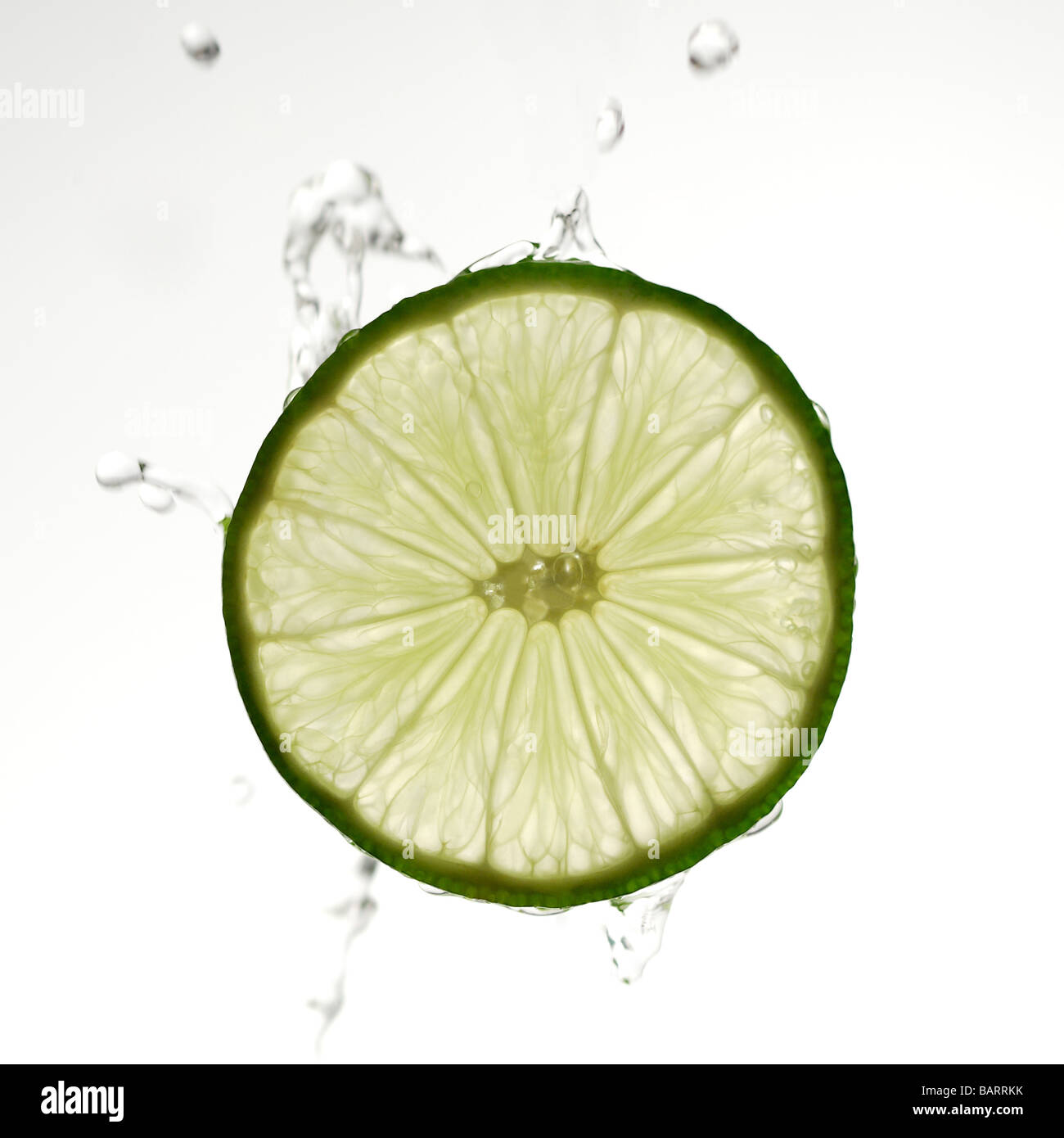 Sliced lemon being dropped in water Stock Photo - Alamy