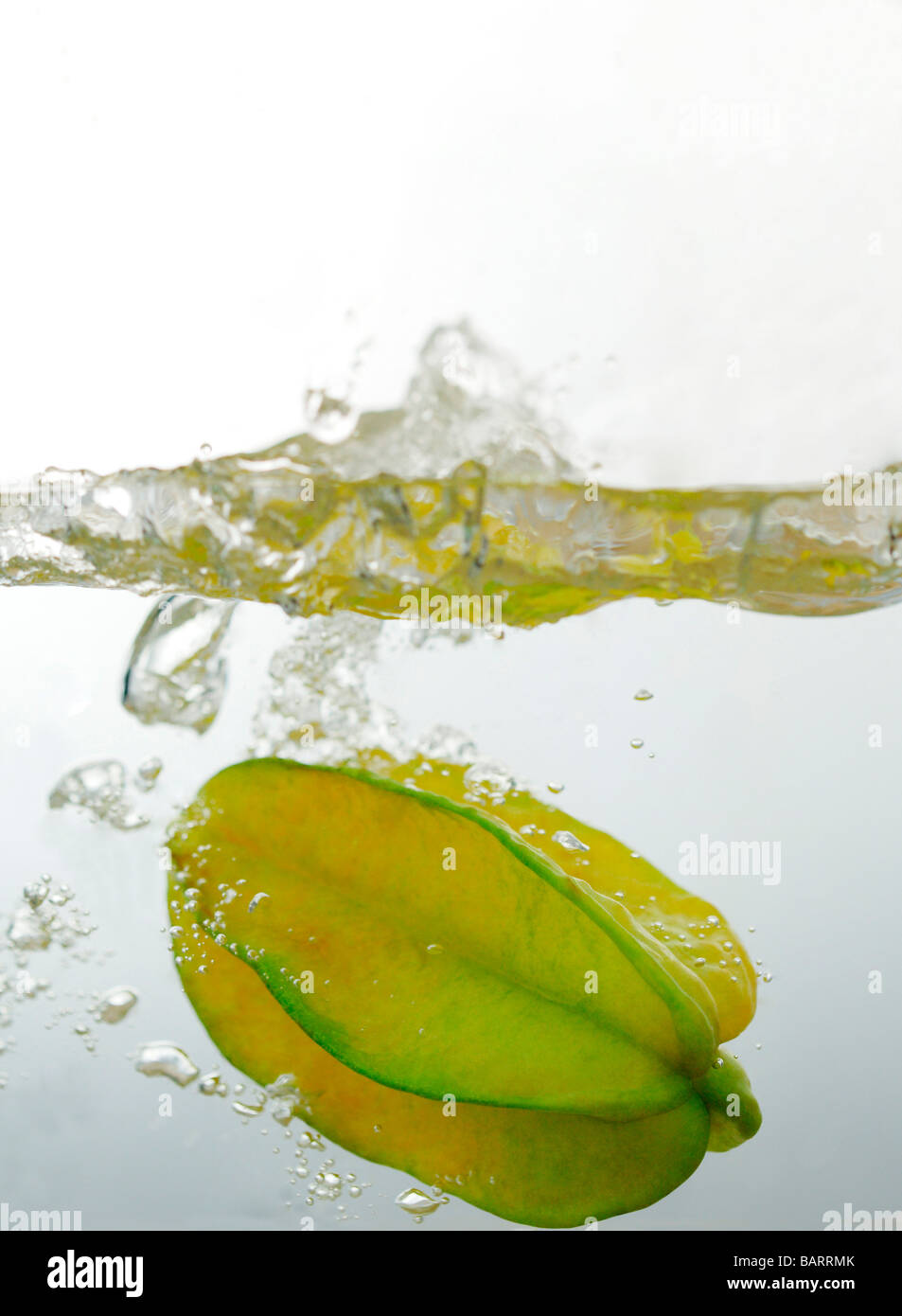 Starfruit falling in water surface view close up Stock Photo - Alamy