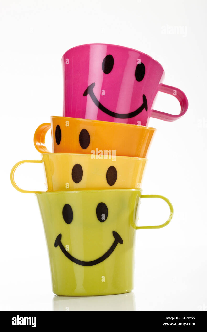 Stacked mugs with smiley face Stock Photo - Alamy