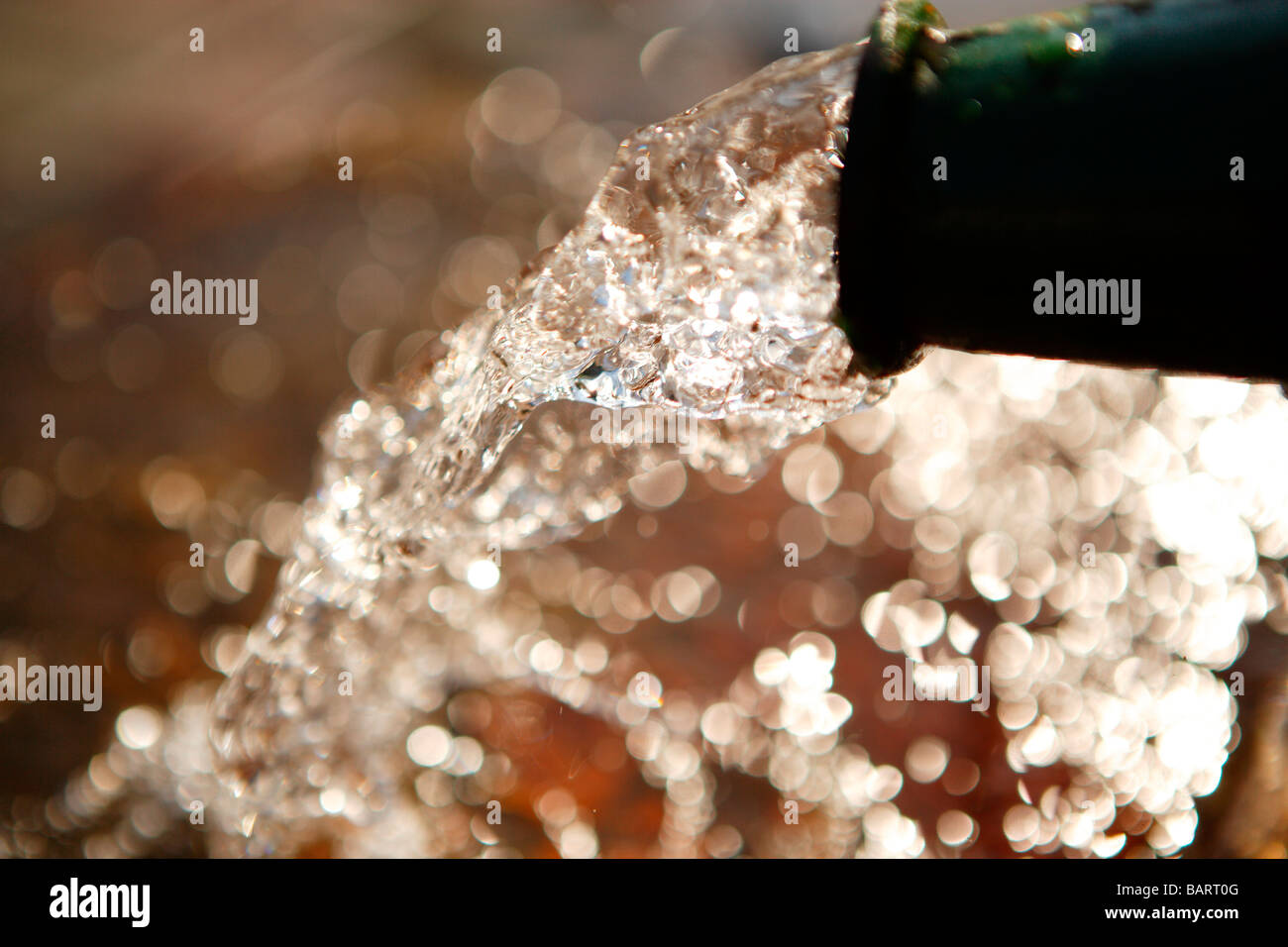 Water pouring from a faucet close up Stock Photo - Alamy