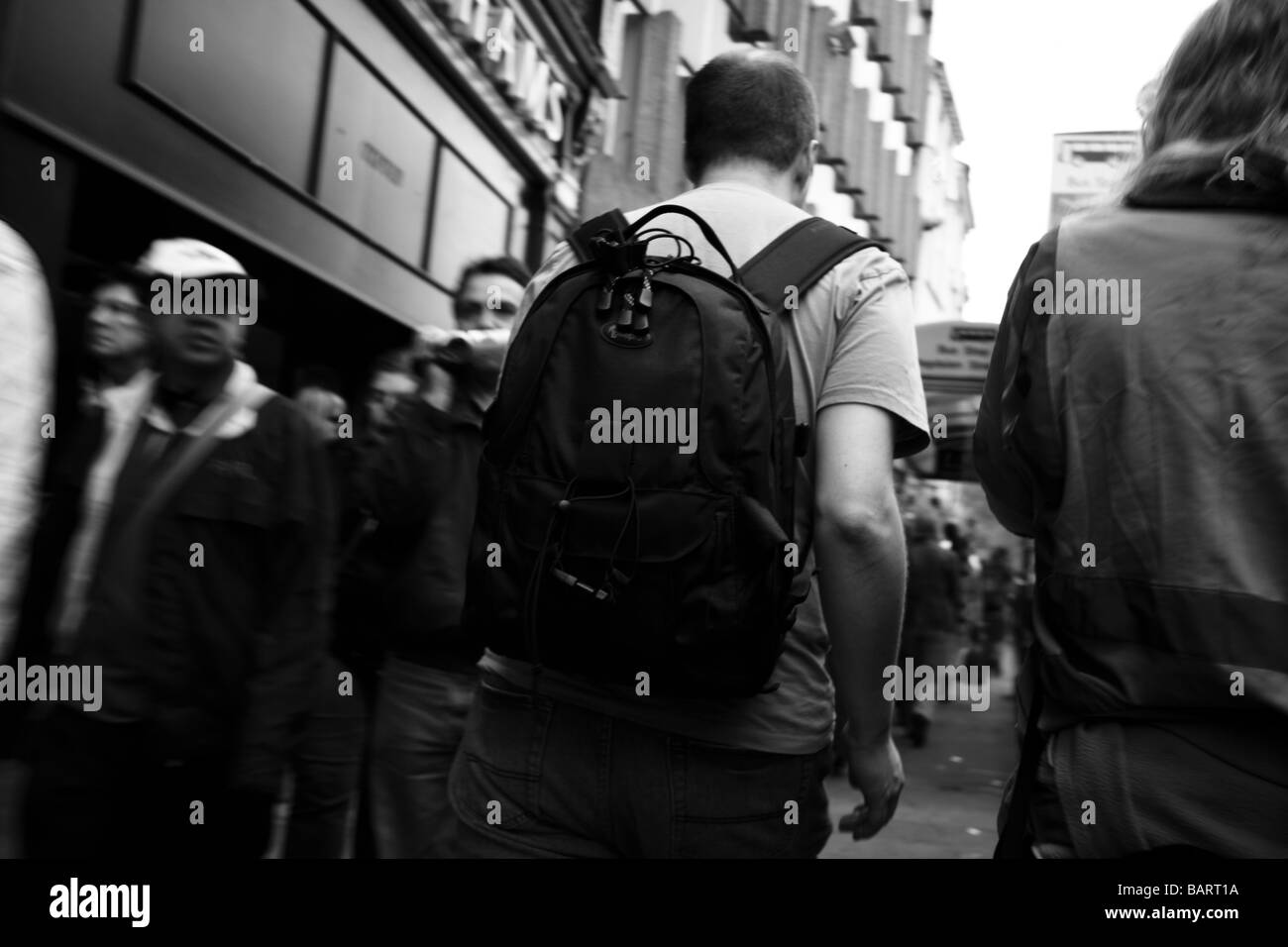Man and Rucksack forge through Crowd Stock Photo - Alamy