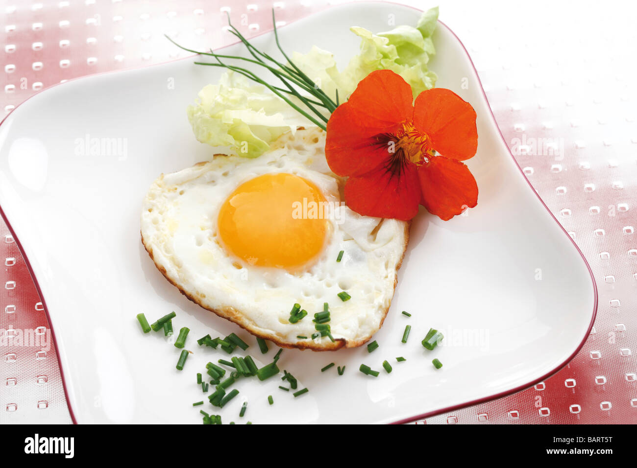 Heart-shaped fried egg on plate Stock Photo - Alamy