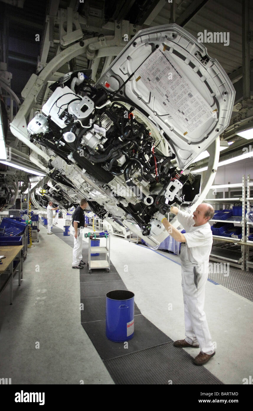 A Worker is working on a VW Golf at Auto 5000 GmbH Volkswagen Group ...