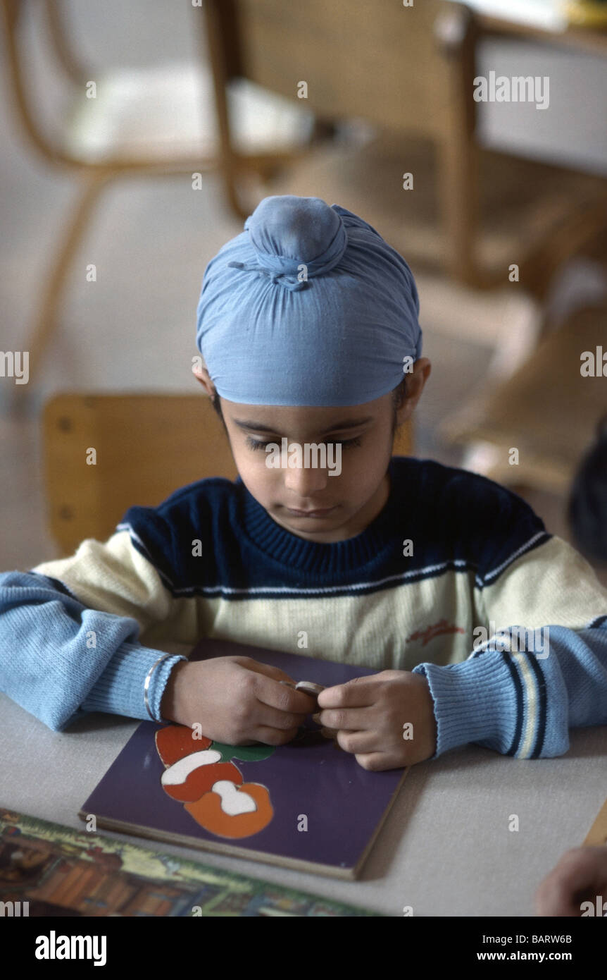 Sikh boy playing with puzzle wearing a patka in a primary school Stock ...