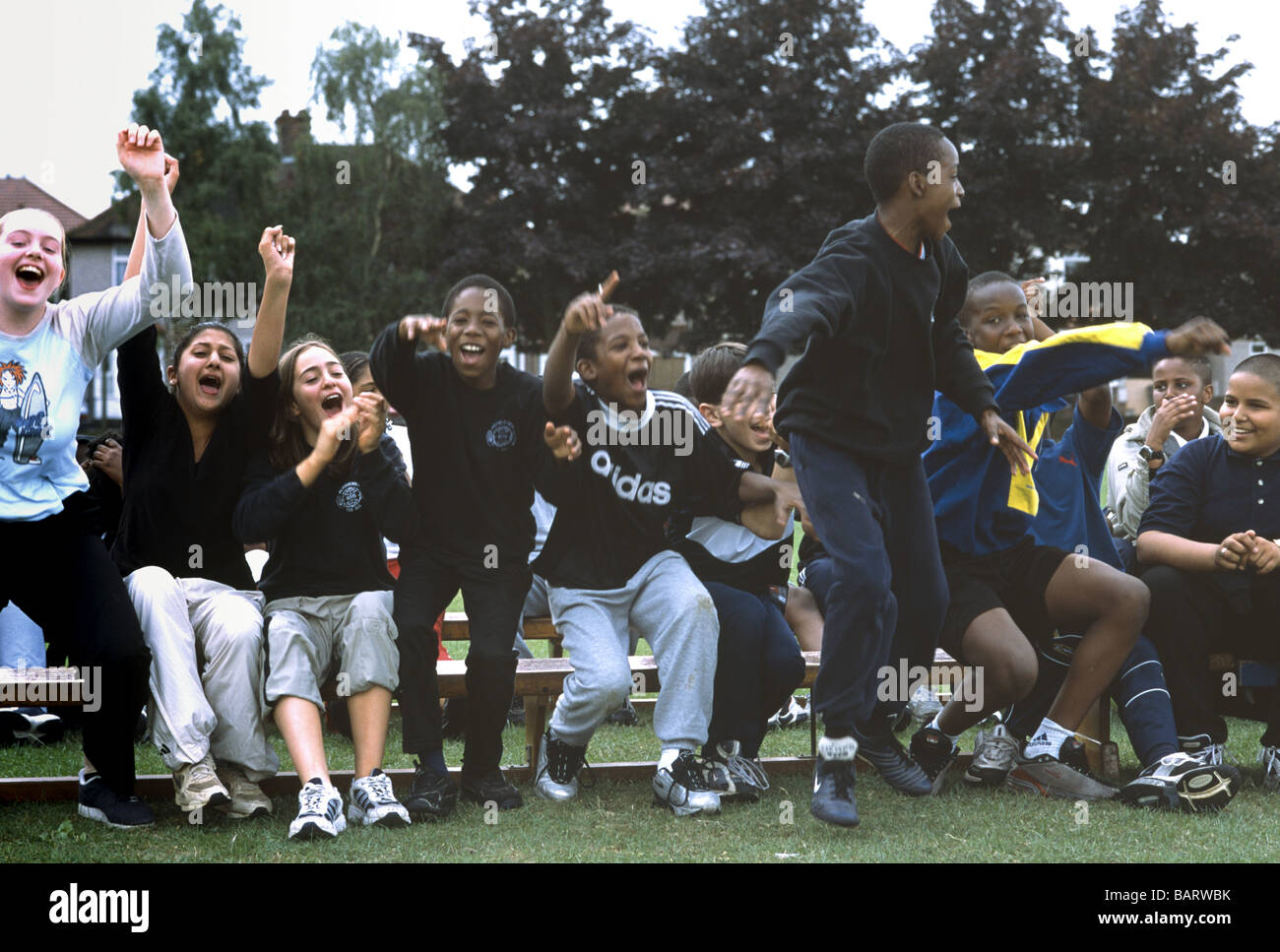 Primary school children cheering classmates at Sports Day race Stock ...